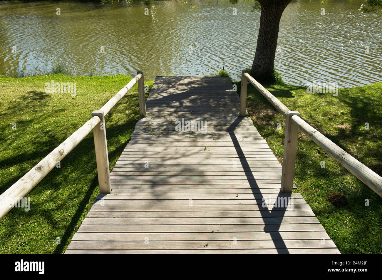Wooden pathway leading to the river in a natural park Stock Photo - Alamy