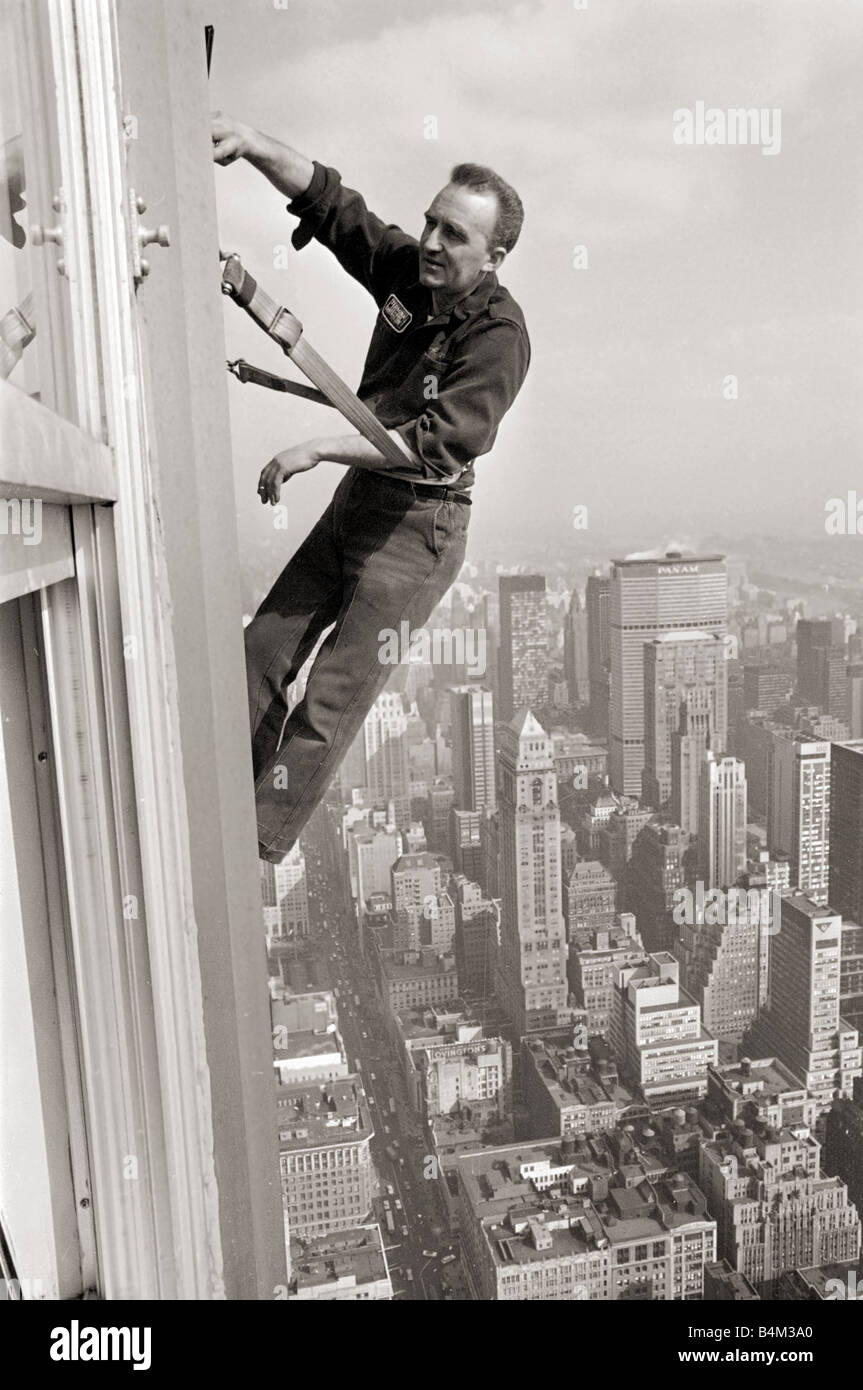 Window Cleaners a 1000 foot above the side walk cleaning the windows of ...