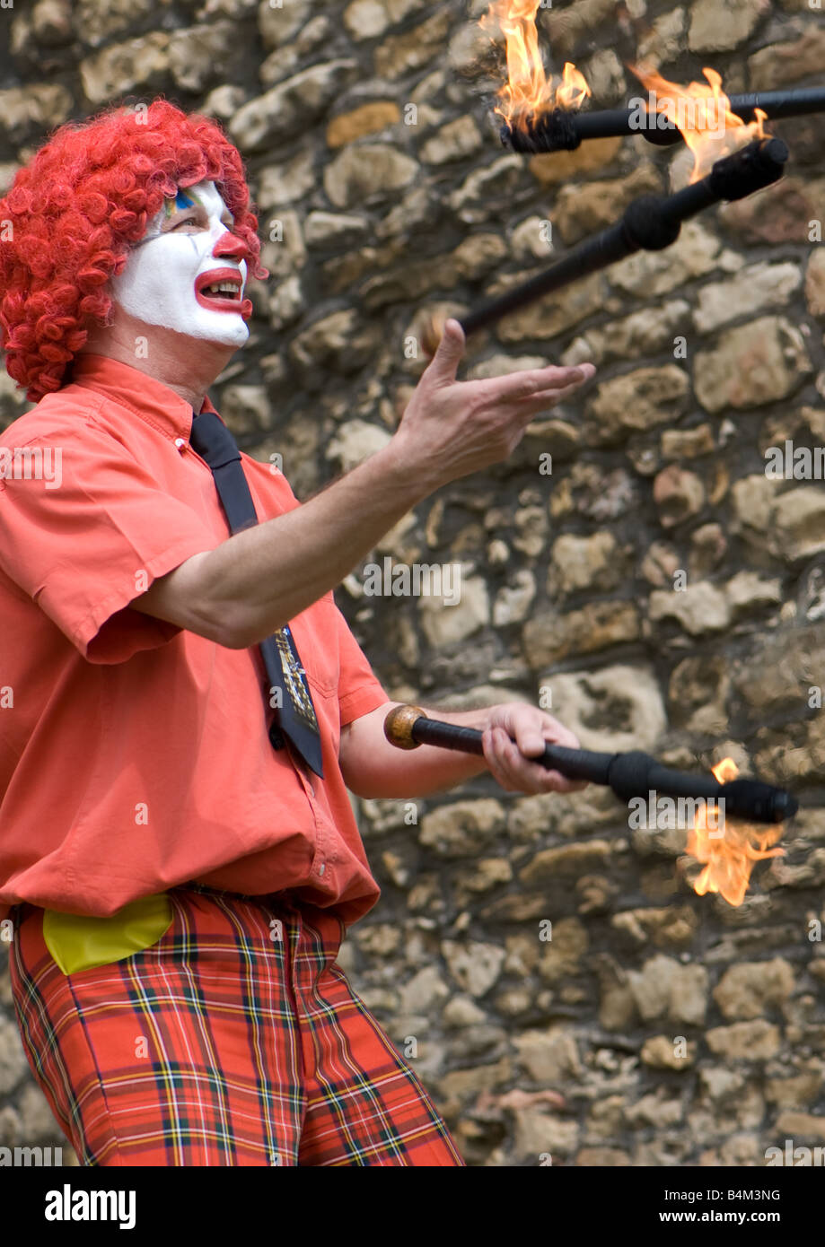 clown juggling with fire Stock Photo - Alamy