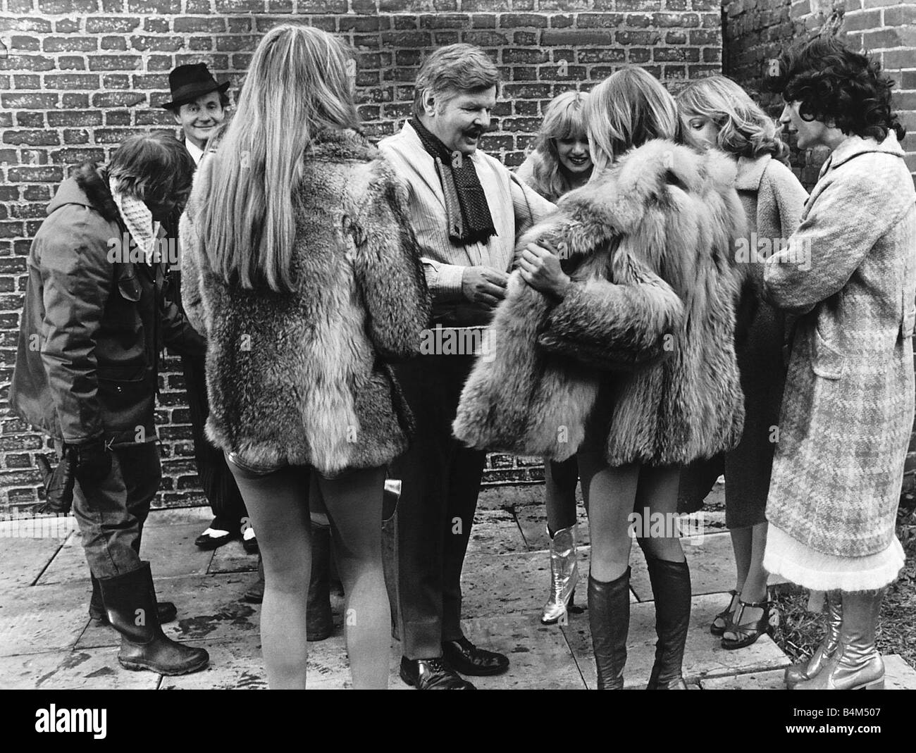 Comedian Benny Hill with girls during filming 1978 Stock Photo - Alamy