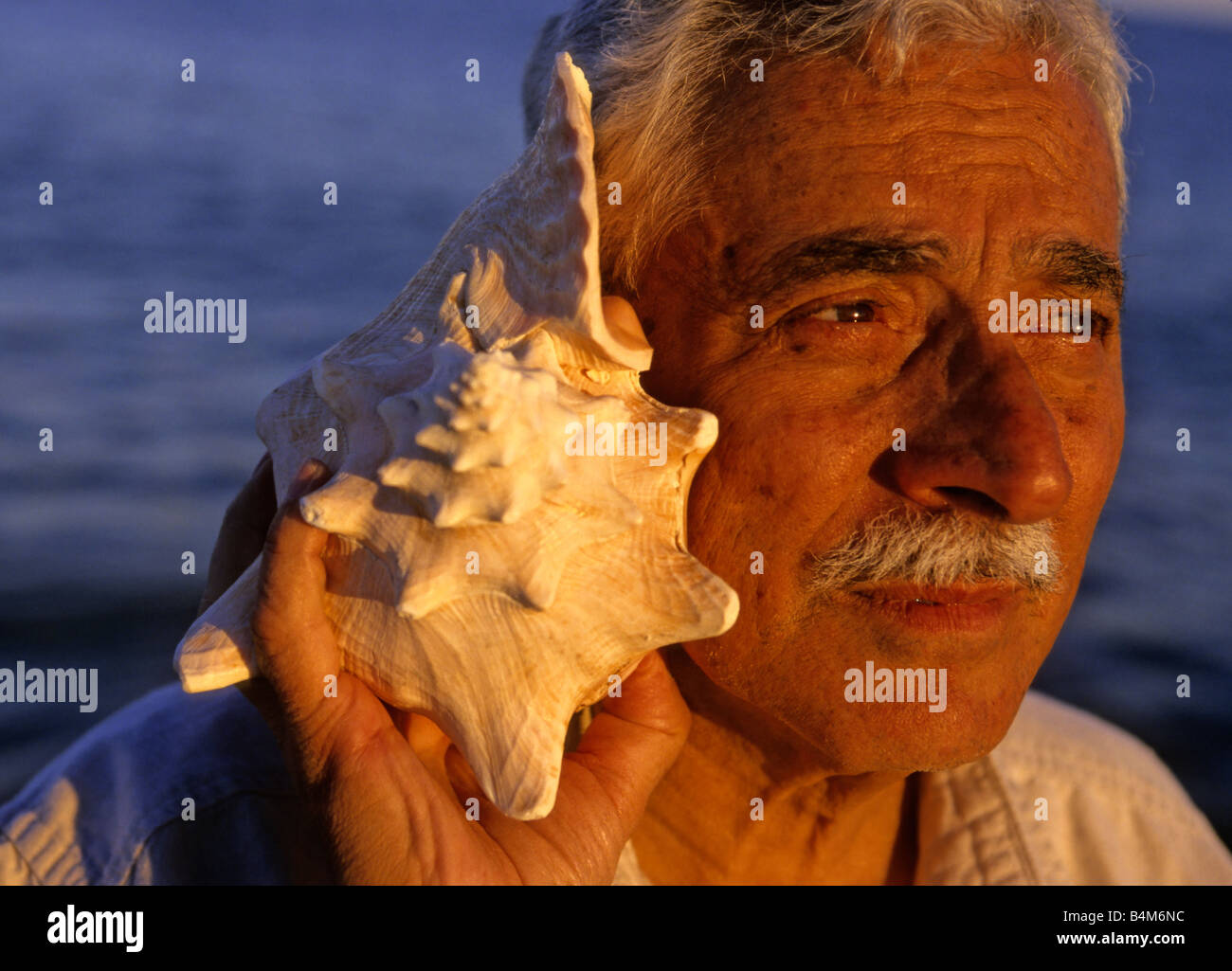 Man listening shell hi-res stock photography and images - Alamy