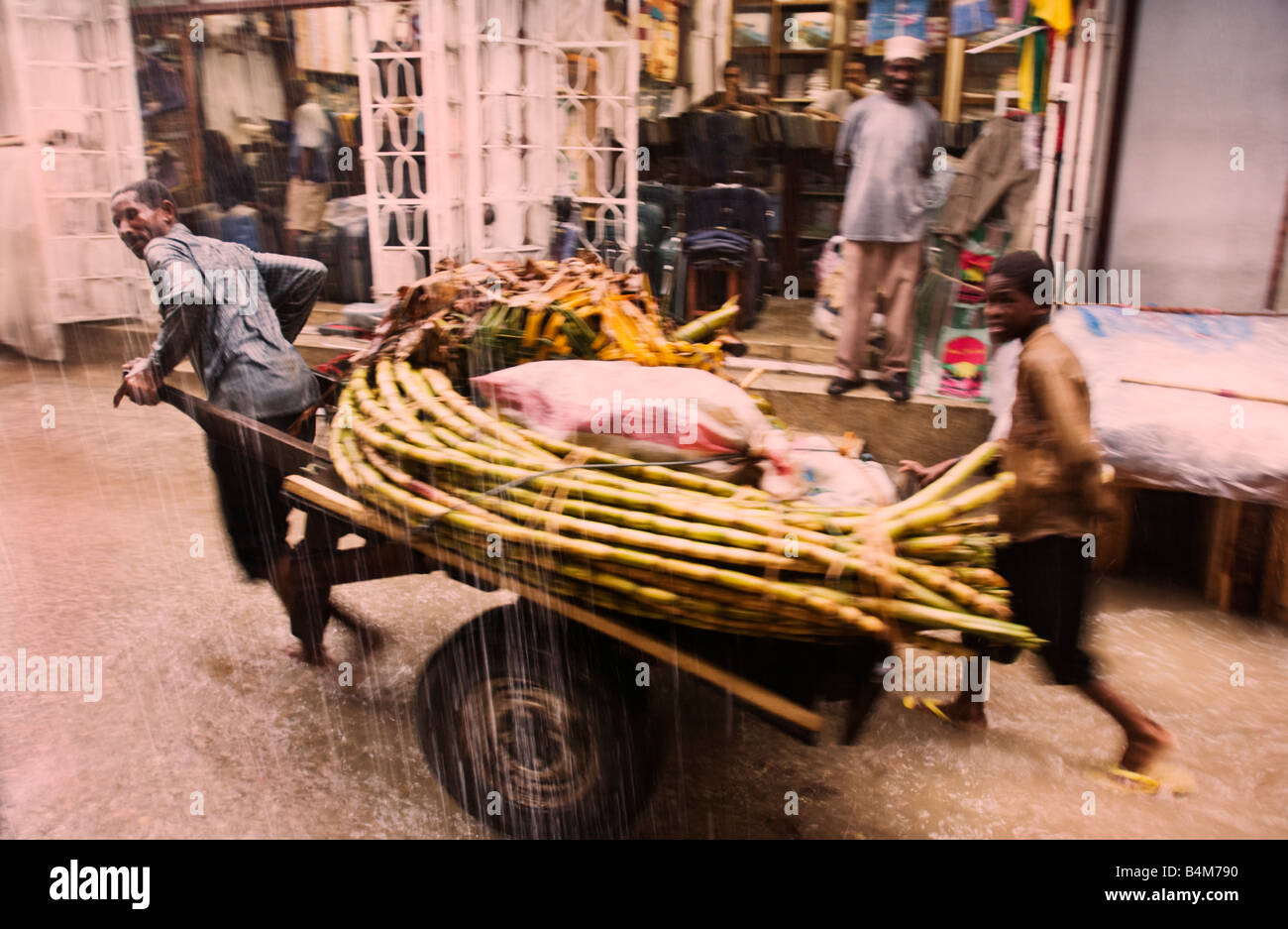 People caught in monsoon seasonal rains in flooded old rustic historic ...