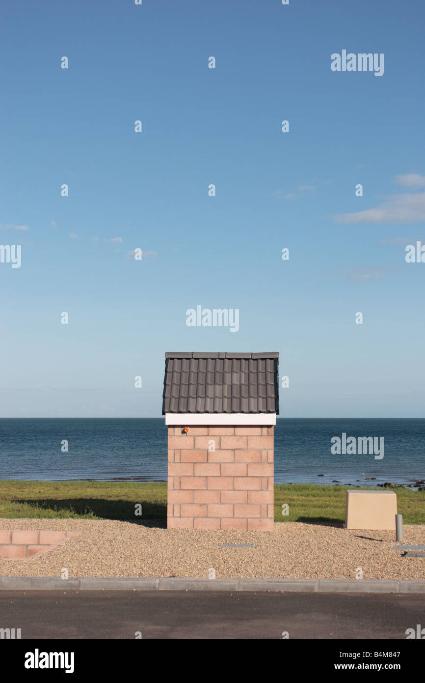 Small breezeblock building with pitched, tiled roof reminiscent of a ...