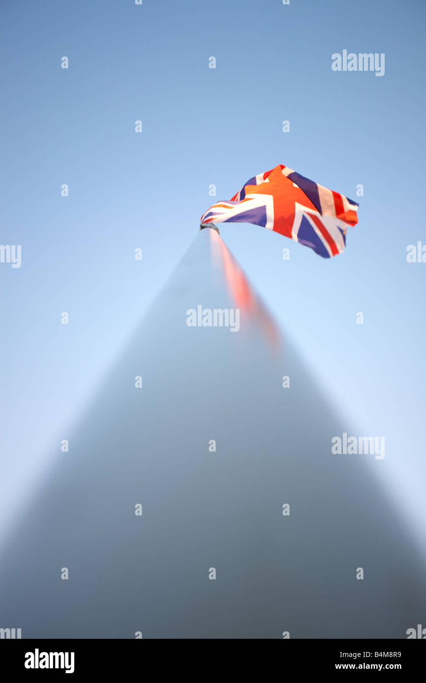 Union Jack National Flag blowing in the wind at the top of a flag pole ...