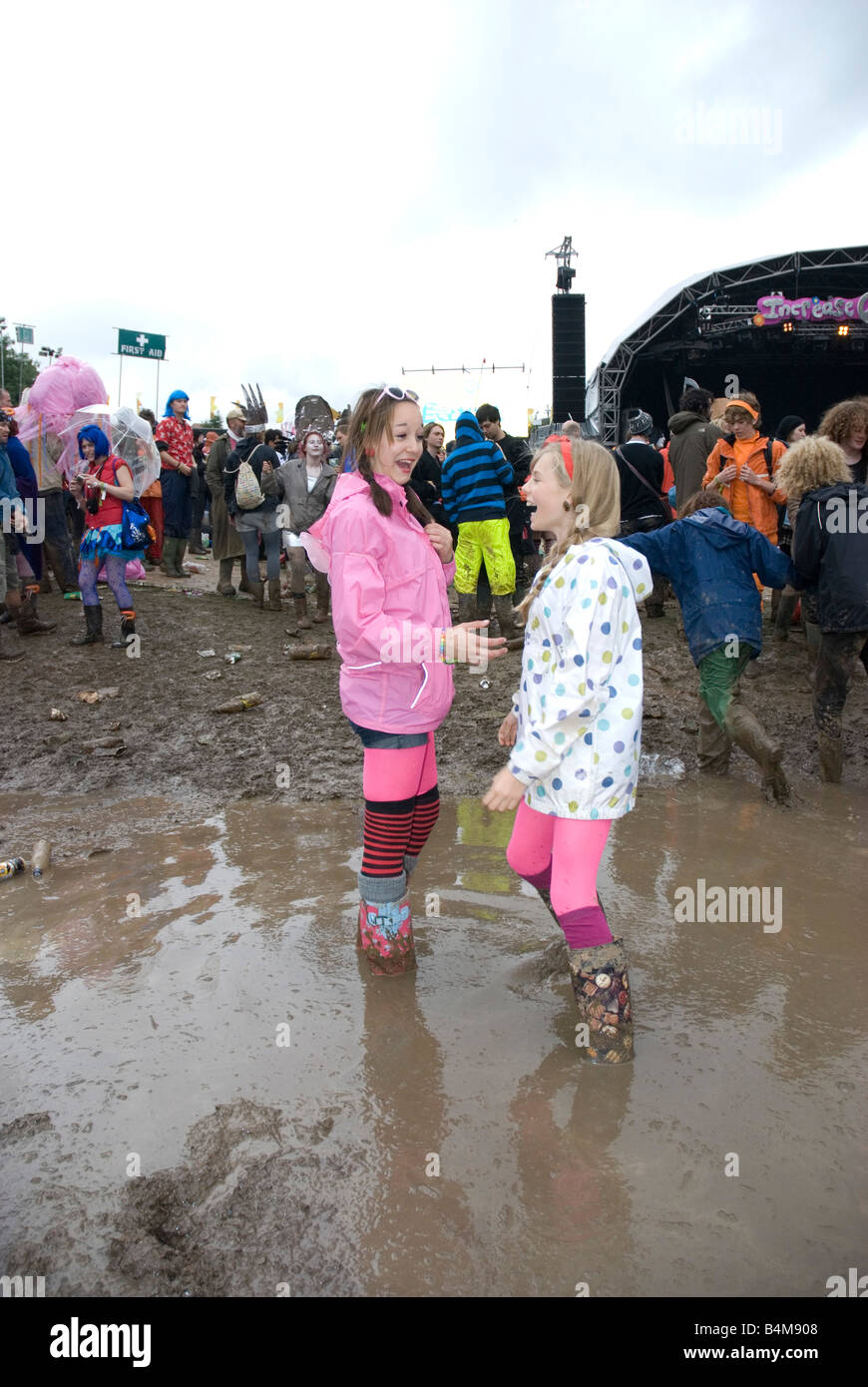 Two girls standing in the mud laughing to the camera, Isle of wight, UK Bestival 2008 Stock ...