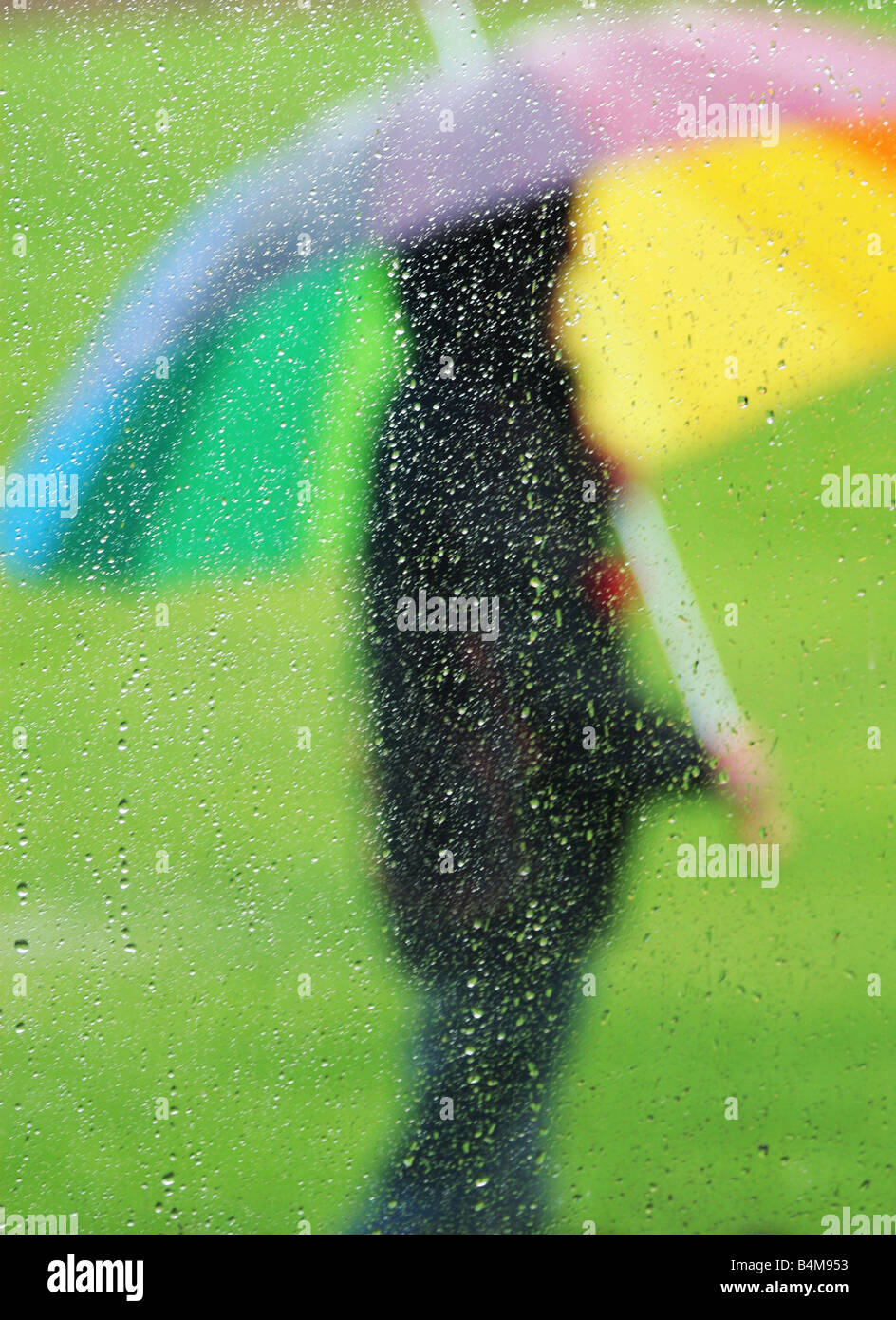 person stood with umbrella in the rain Stock Photo - Alamy