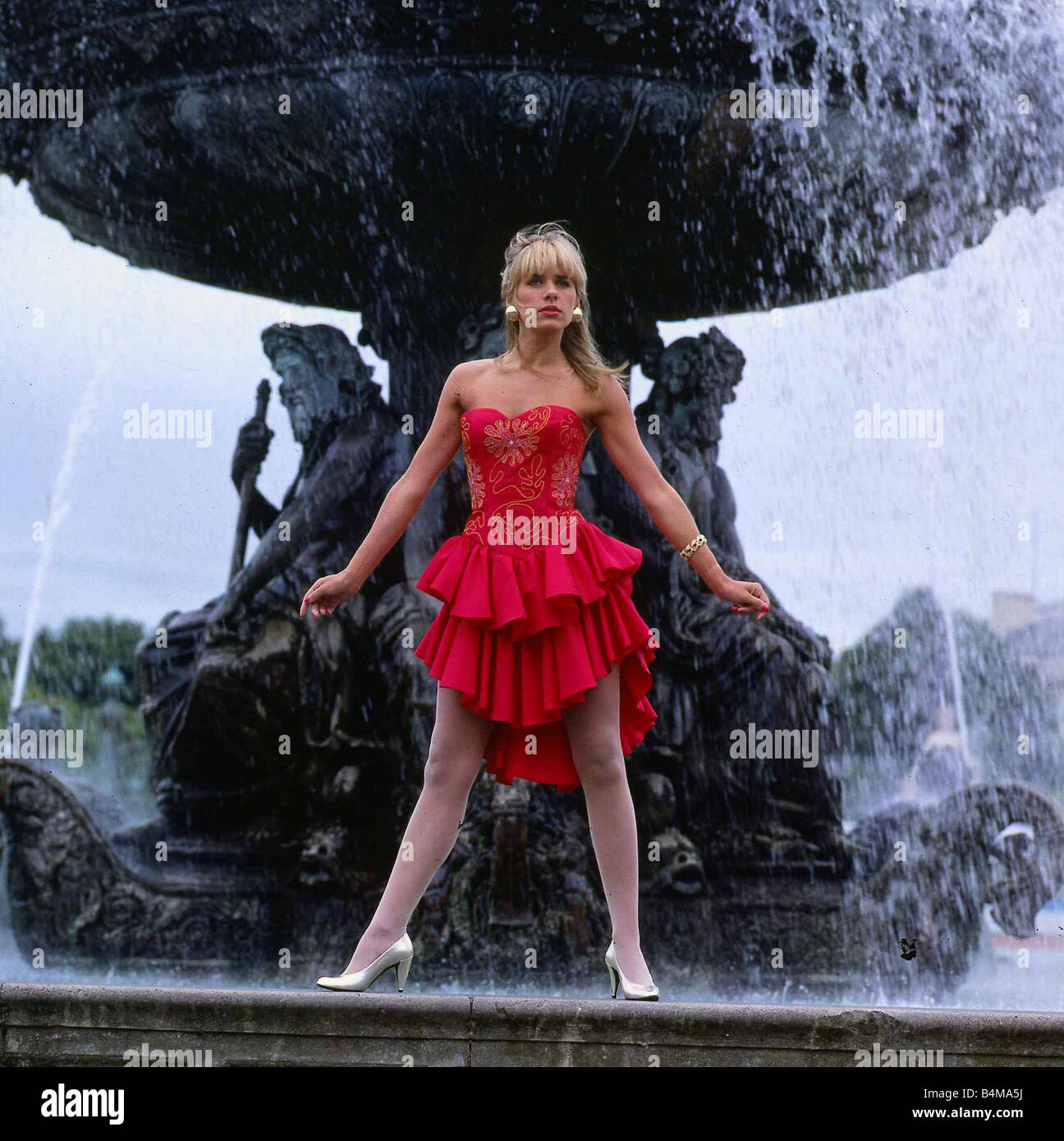 Carol Smillie model TV presenter wearing red dress standing ion front ...