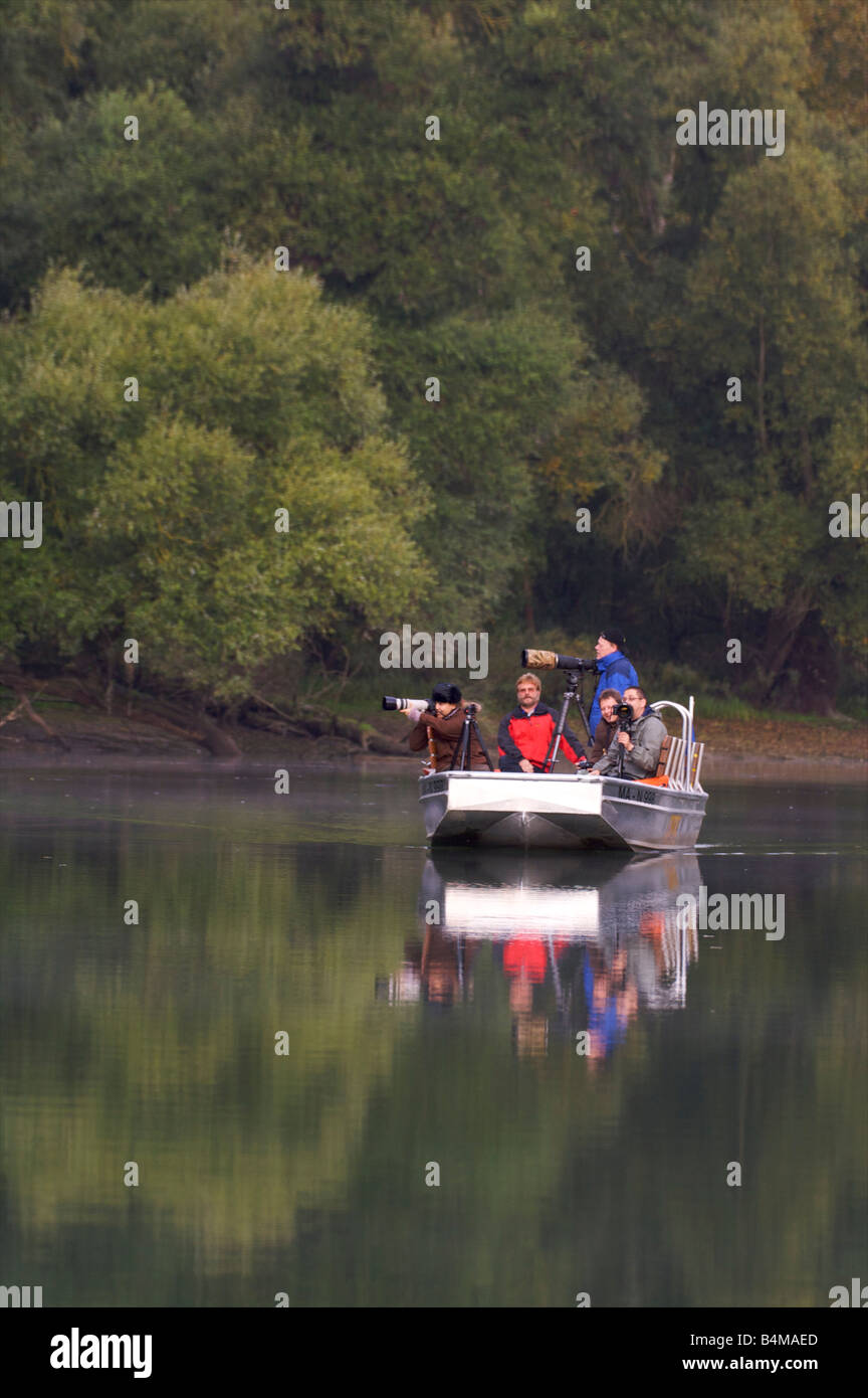 Group of photographers into a boat on a lake Stock Photo - Alamy
