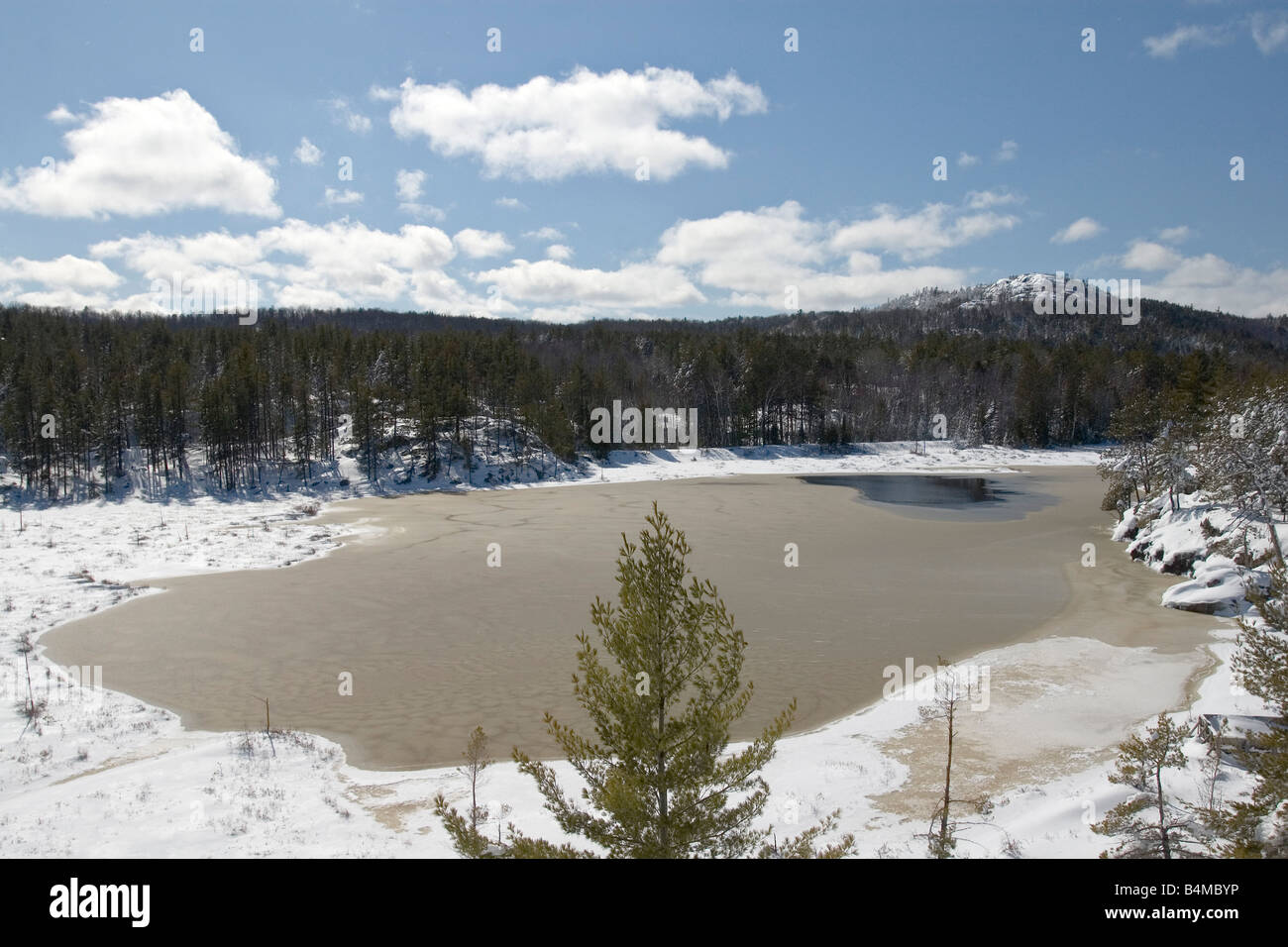A frozen pond and snow covered hill in Michigan s Upper Peninsula Stock ...