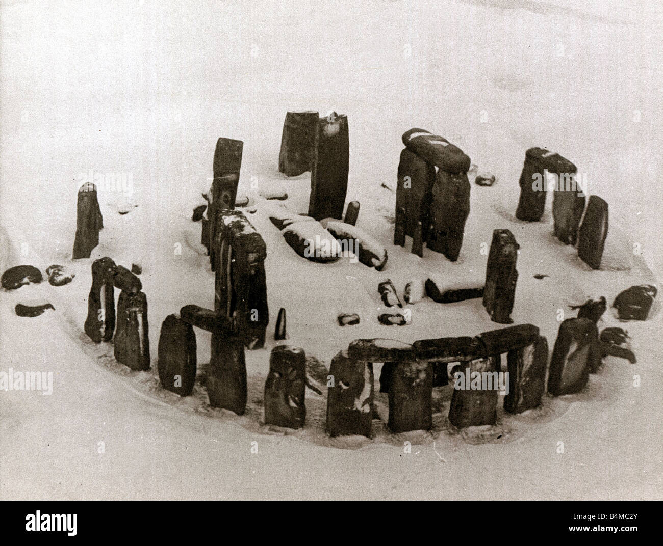 An aerial view of the ruins of Stonehenge in Wiltshire covered in snow ...