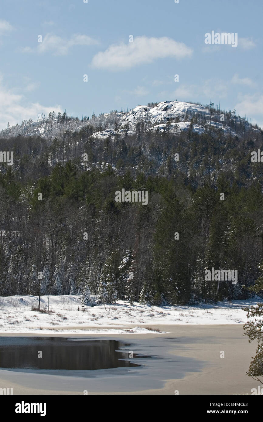 A frozen pond and snow covered hill in Michigan s Upper Peninsula Stock ...