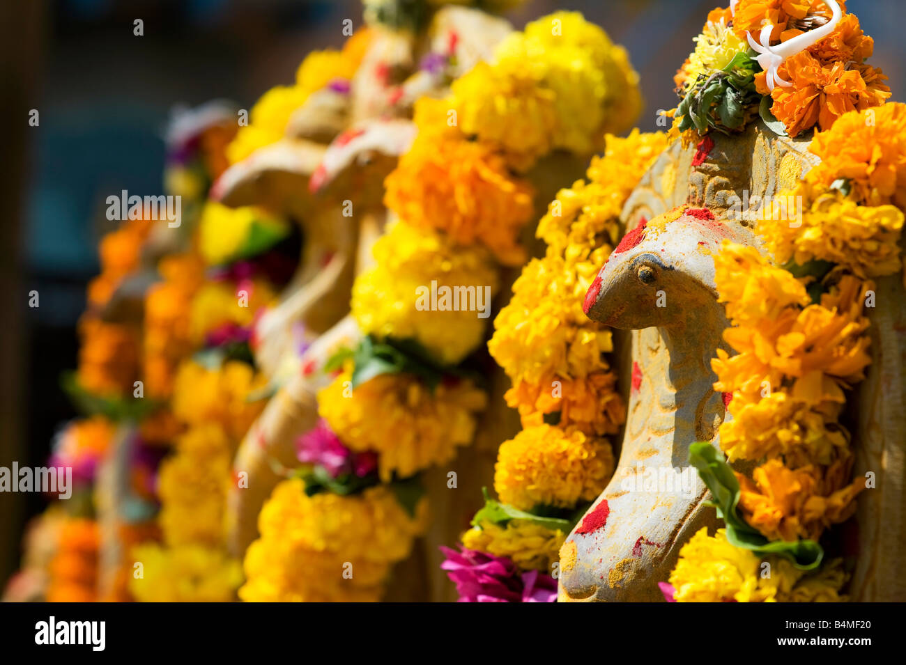 Naga. Indian cobra deity stone idols covered in flower garlands for ...