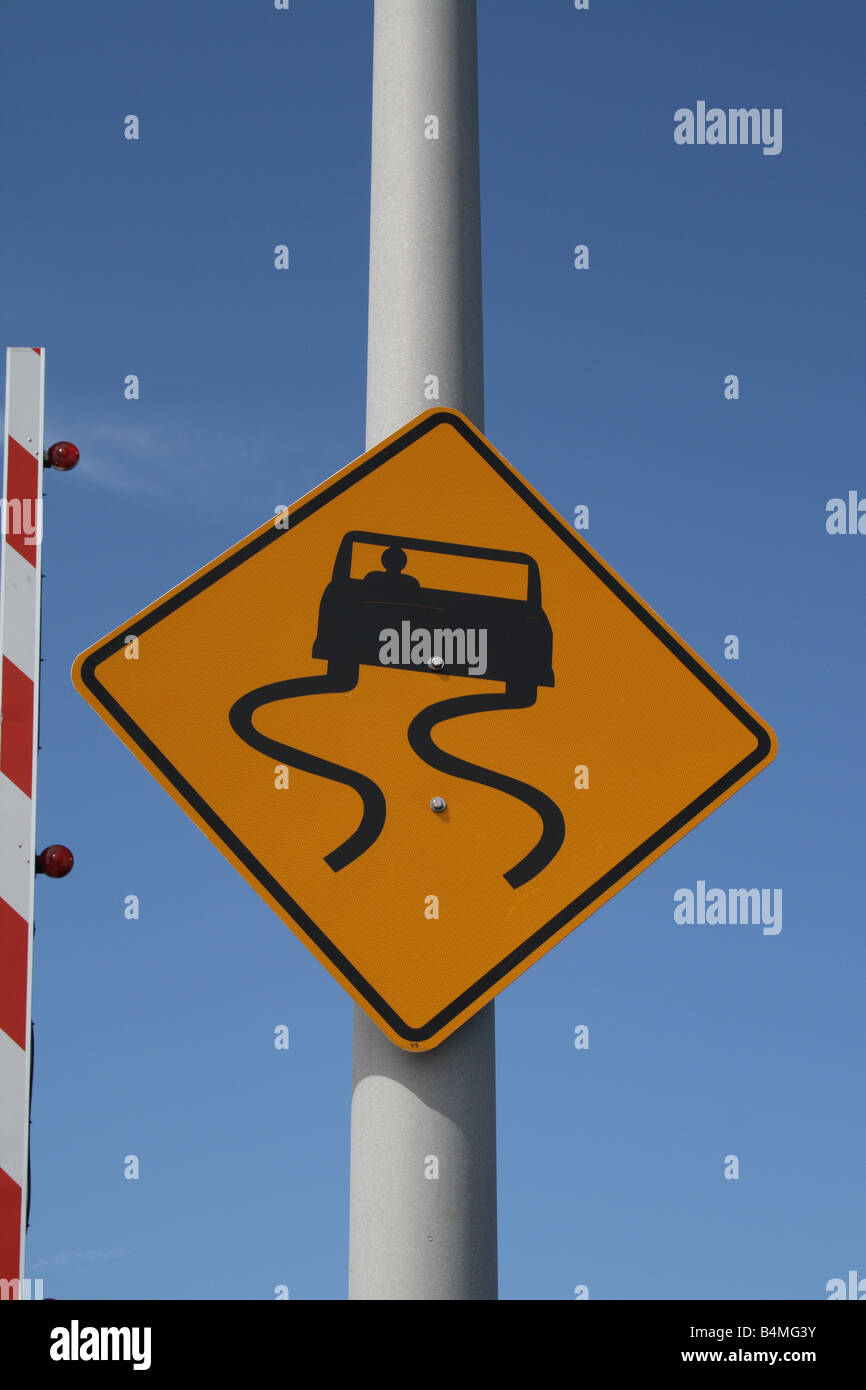 Close-up of Slippery When Wet Warning sign on bridge Stock Photo - Alamy