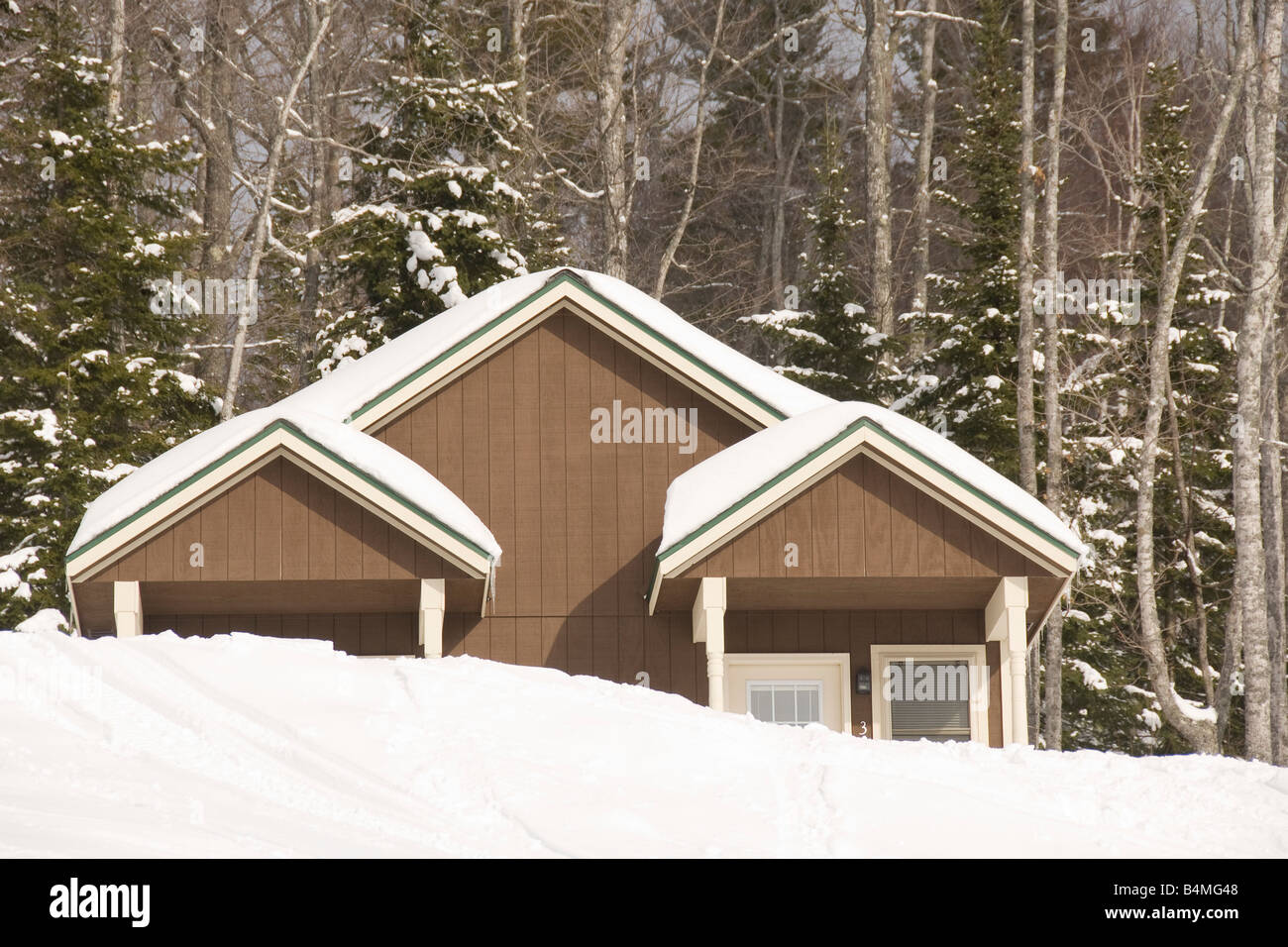 A large snowbank partially obscures a trailside lodging cabin at Mount ...