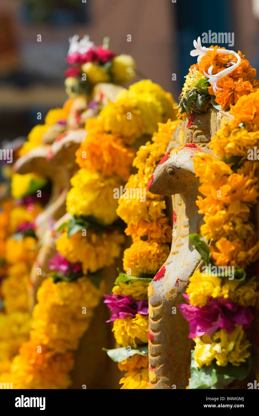 Naga. Indian cobra deity stone idols covered in flower garlands for ...