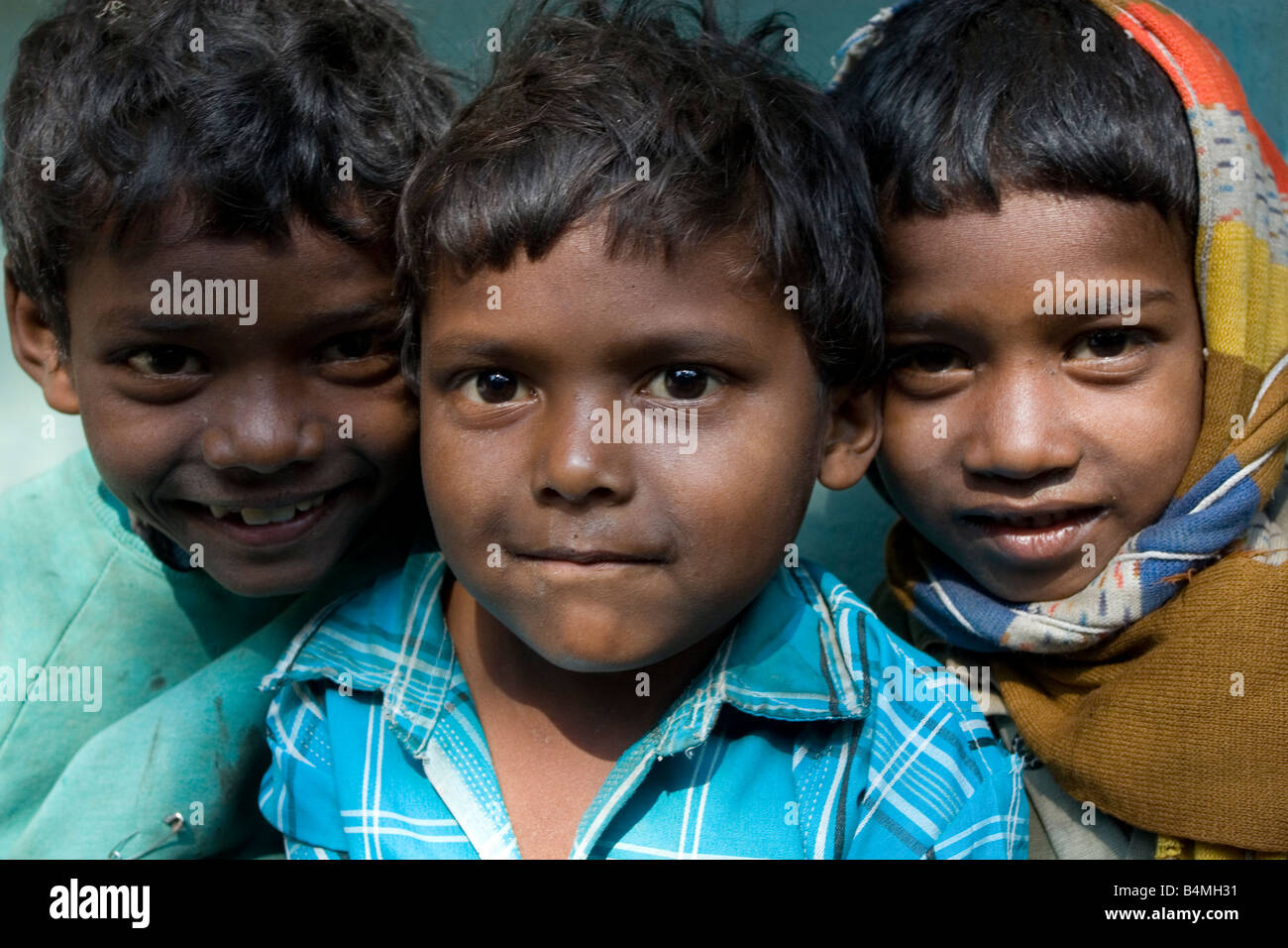 Three tribal boys shares a happy moment at a tribal village of West ...