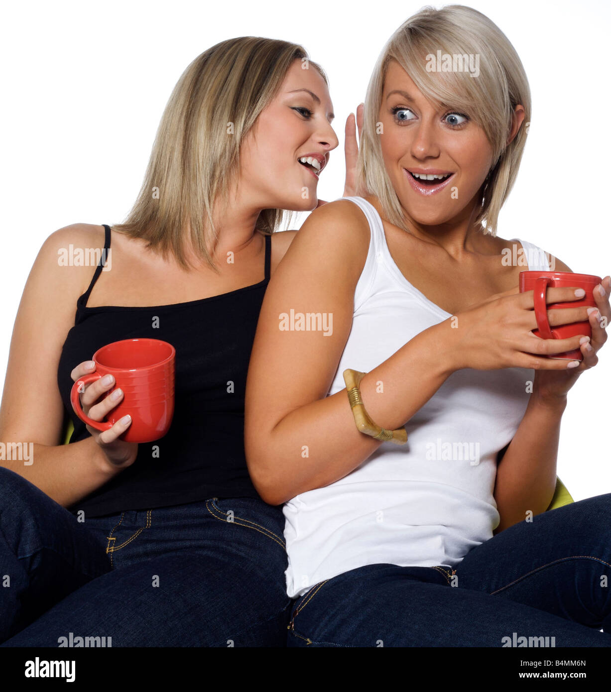 Young women sharing a secret Stock Photo - Alamy