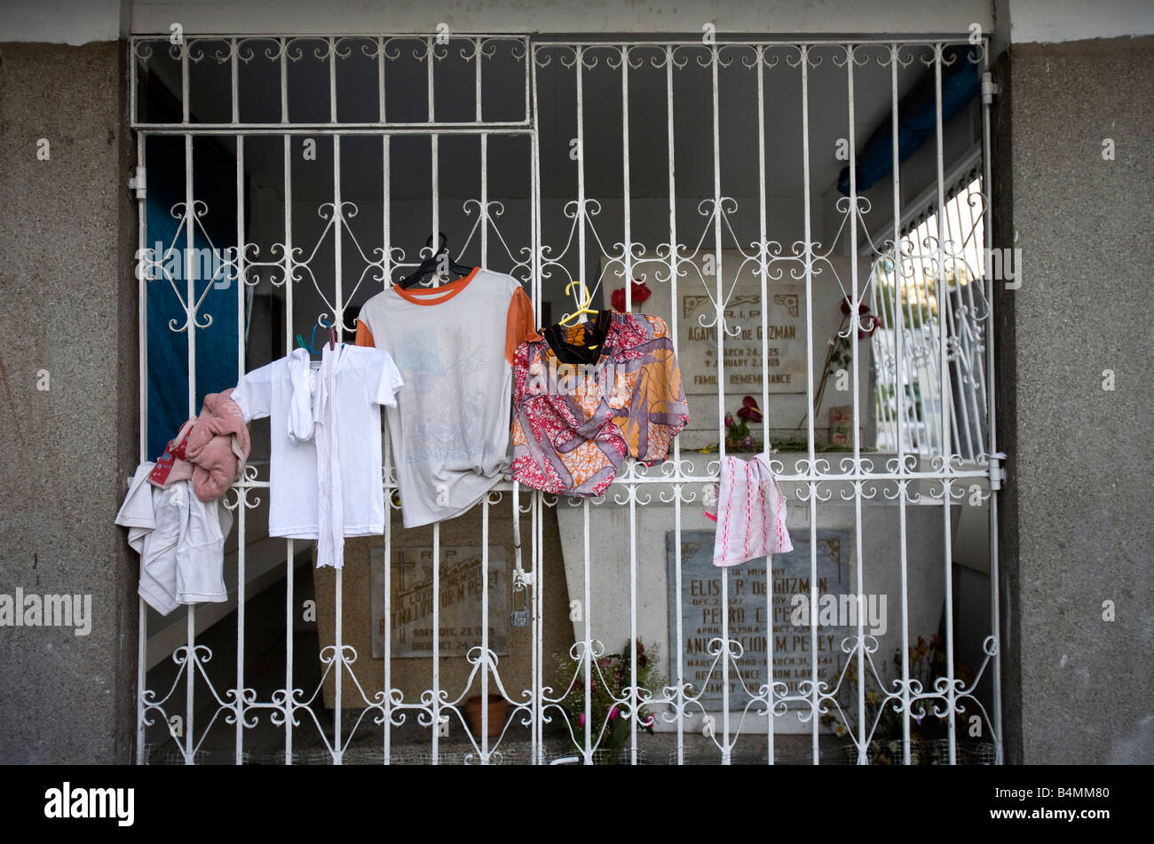 A Filipino family's laundry is hung out to dry on a mausoleum at the ...