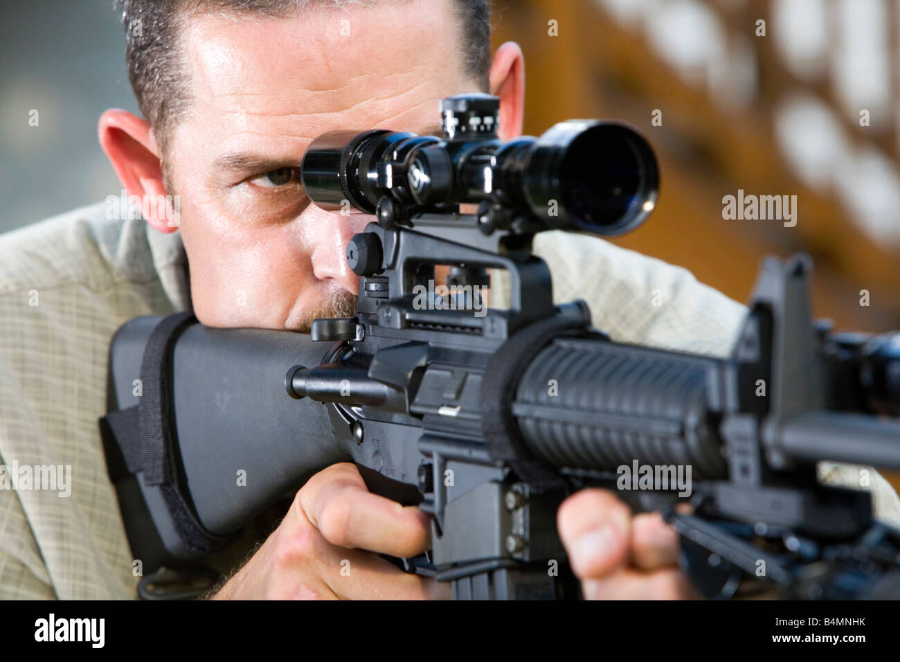 A man aims an AR 15 Bushmaster rifle Stock Photo - Alamy