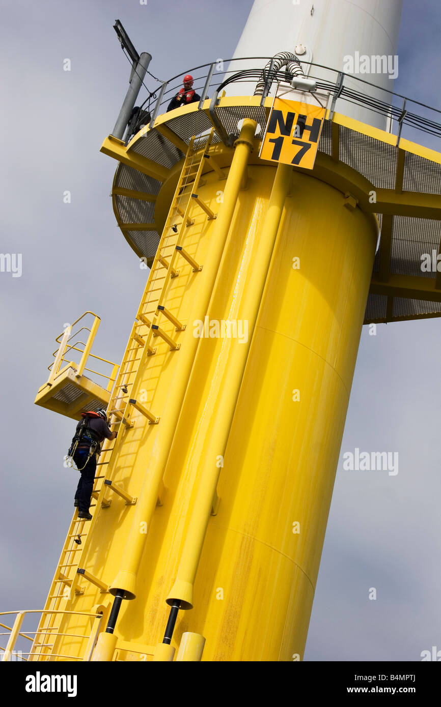 Maintenance engineer climbing tower of wind turbine of North Hoyle ...