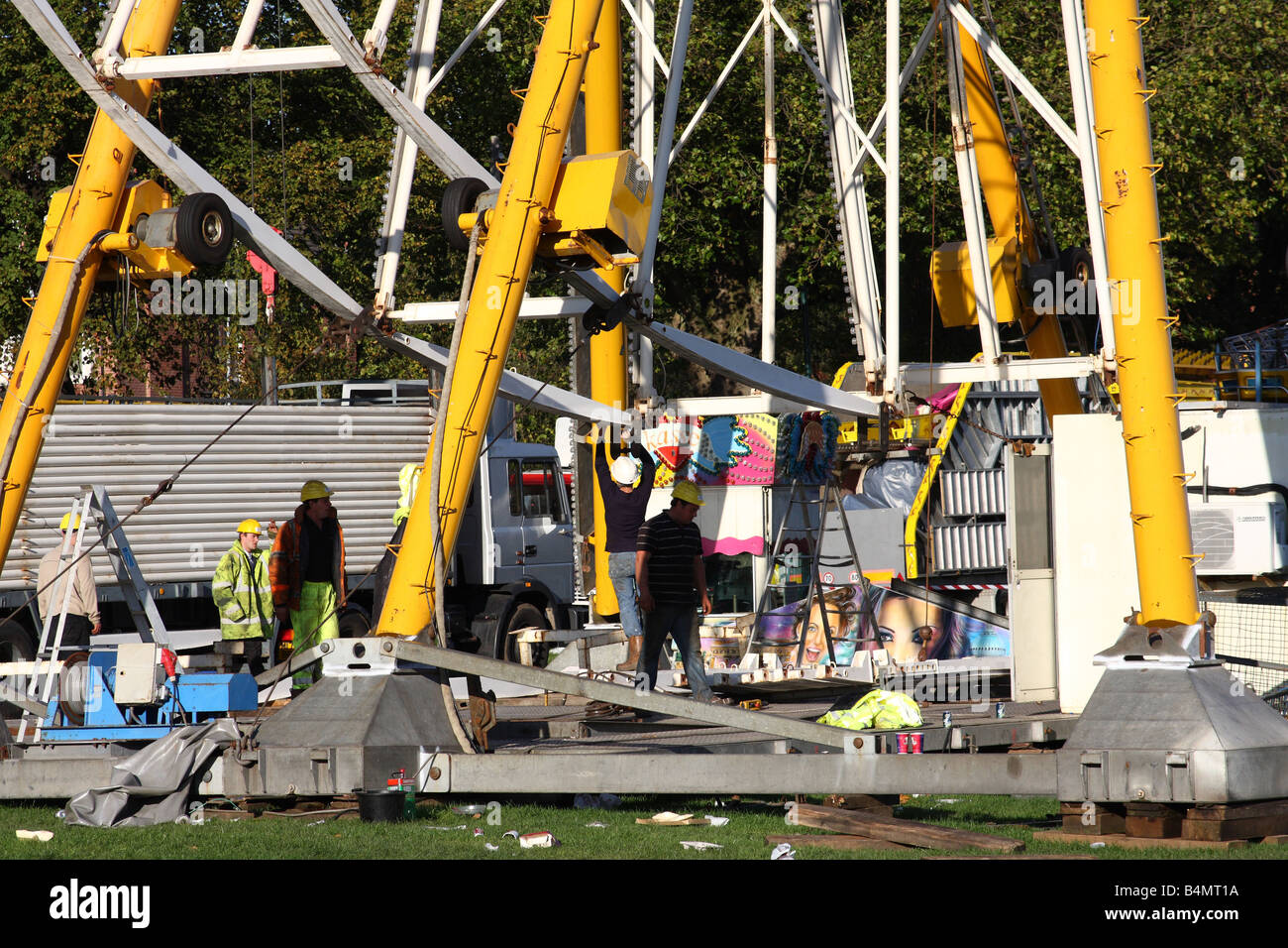 Workers dismantle a fairground ride at the Nottingham Goose Fair ...