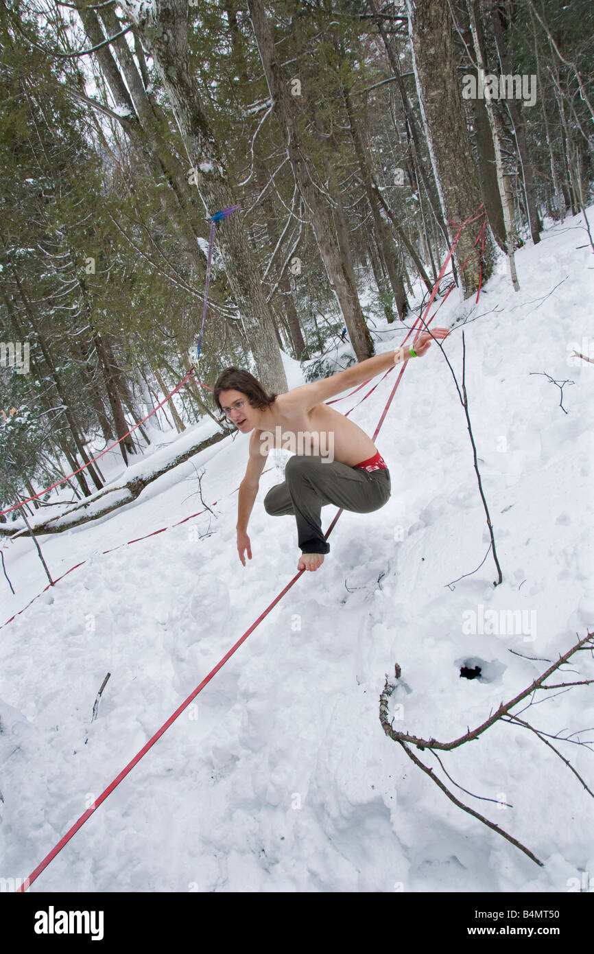 Man on a slackline, shirtless in winter, Michigan Ice Fest Munising ...