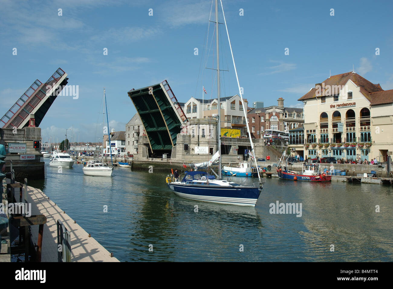 yachts passing through the Town Bridge, Weymouth, Dorset, England, UK ...