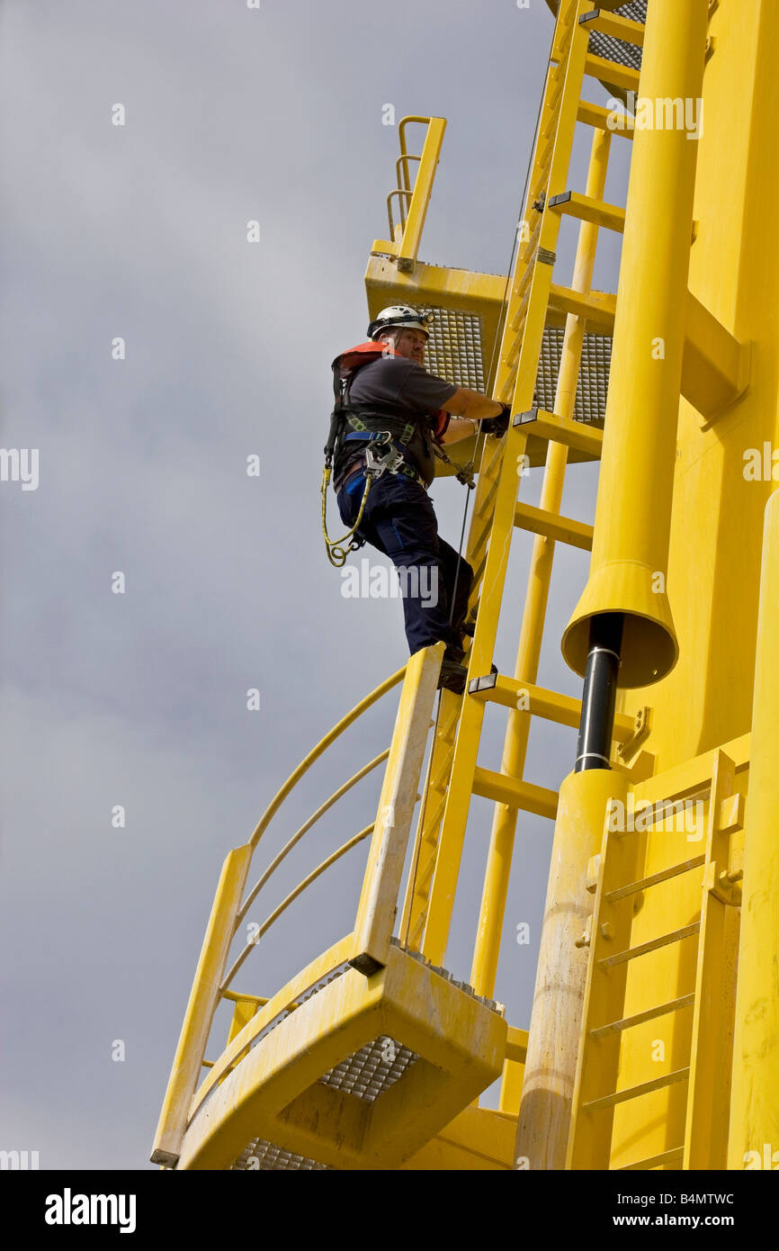 Maintenance engineer climbing tower of wind turbine of North Hoyle ...