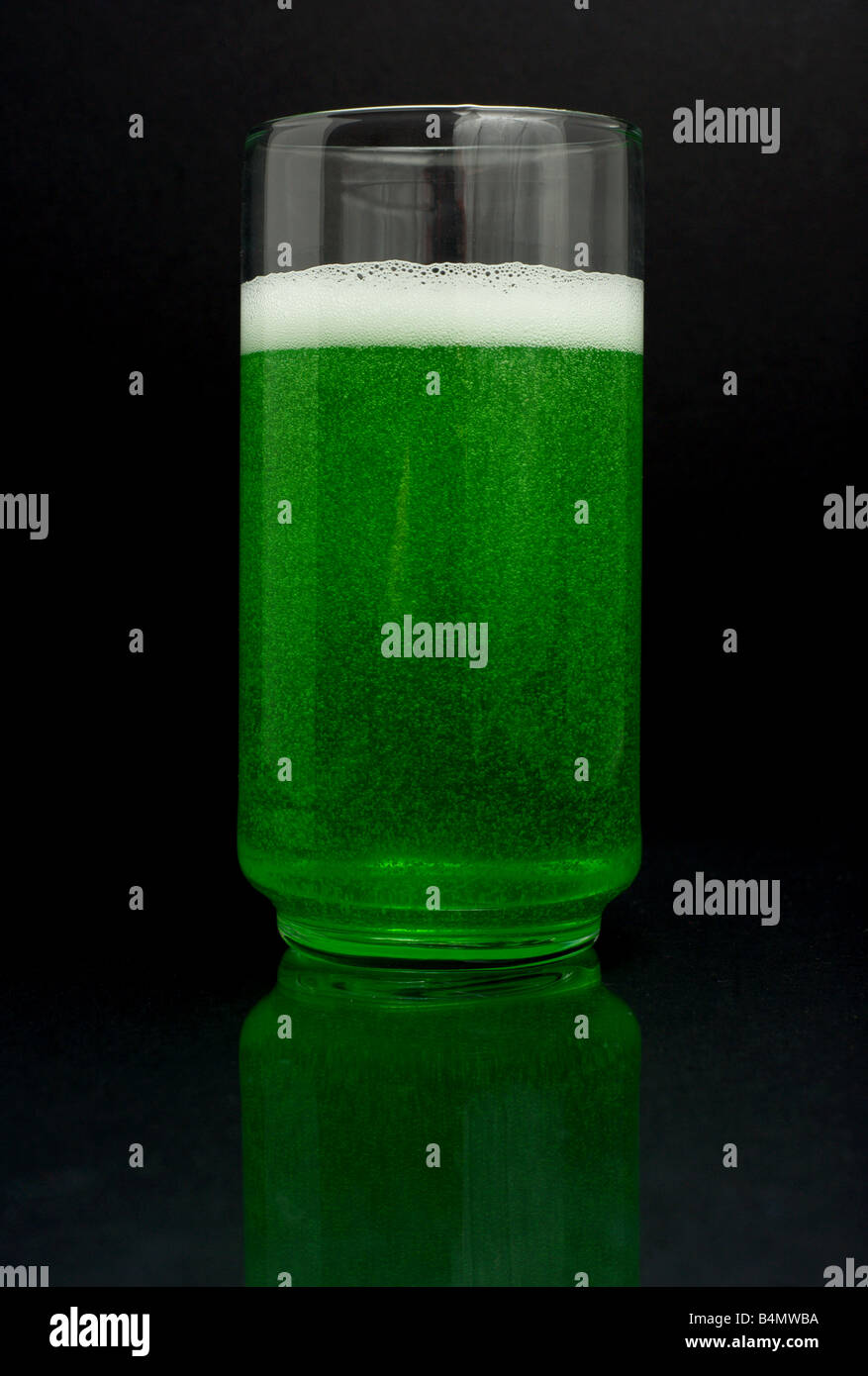 Clear glass filled with bubbly green liquid Stock Photo - Alamy