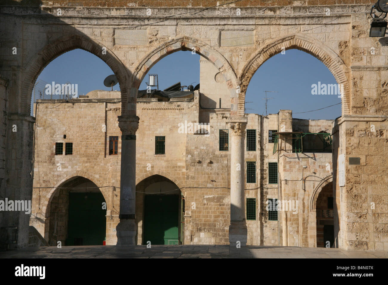 Ancient columns frame buildings near the Dome of the Rock on Temple ...