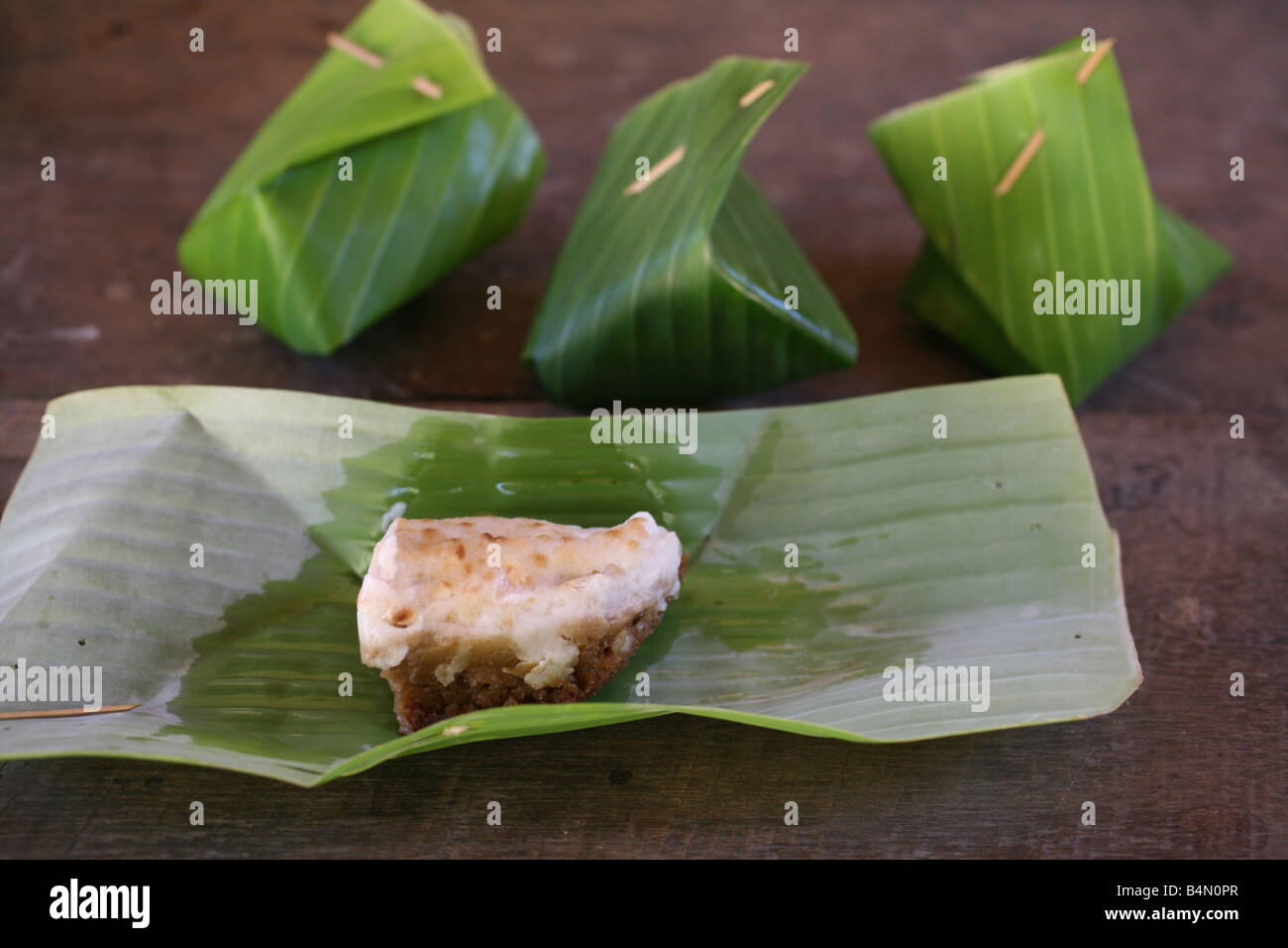Closeup of food wrapped in banana leaves Approximately 300 Burmese ...