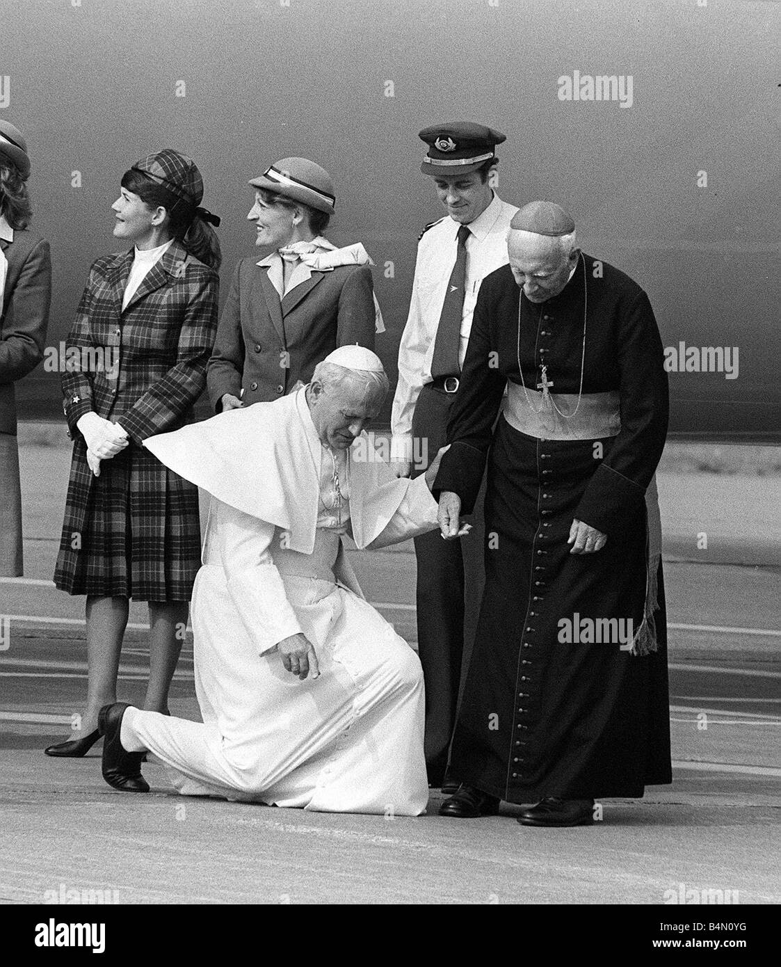 Pope John Paul II at Cardiff airport on his visit to Wales kneels down ...