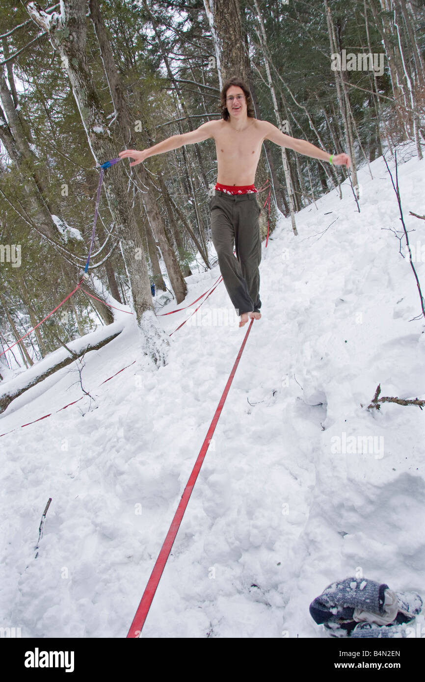 Man on a slackline, shirtless in winter, Michigan Ice Fest Munising ...