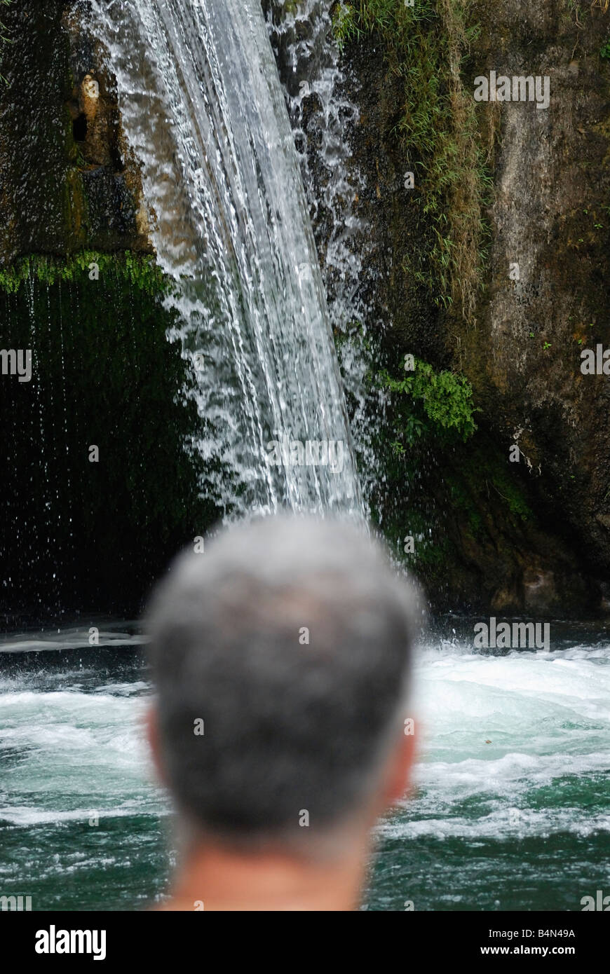 a person in front of a waterfall Stock Photo - Alamy