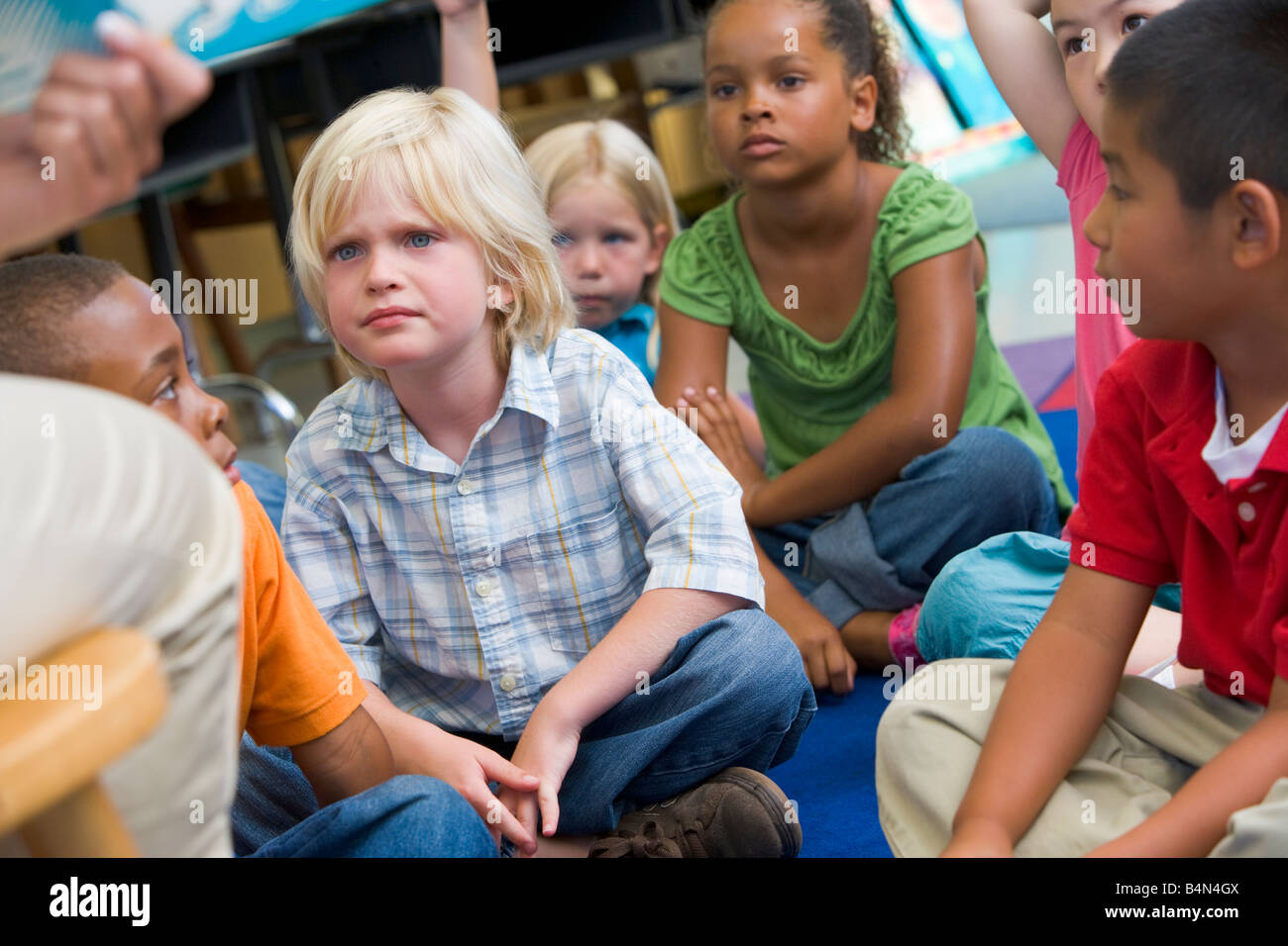 Sitting on the floor with group of children in kindergarten hi-res ...
