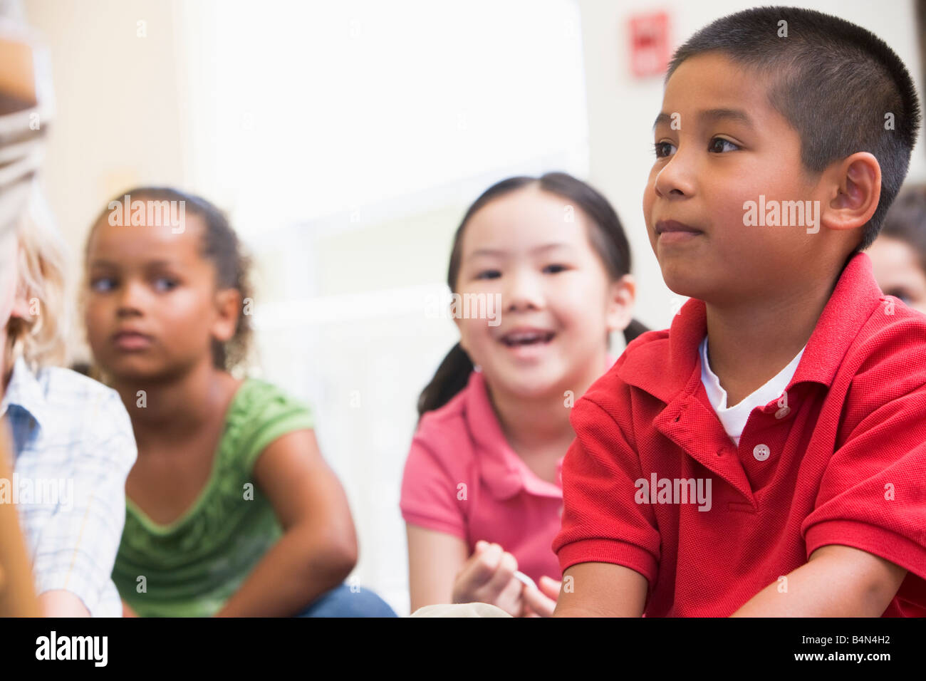 Sitting on the floor with group of children in kindergarten hi-res ...
