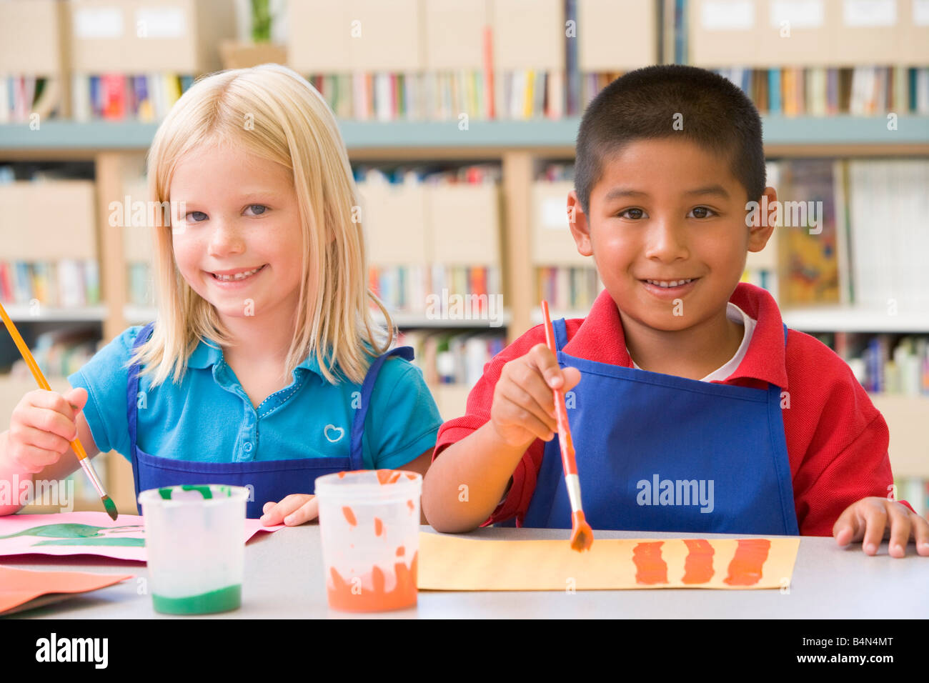 Two students in art class painting Stock Photo - Alamy