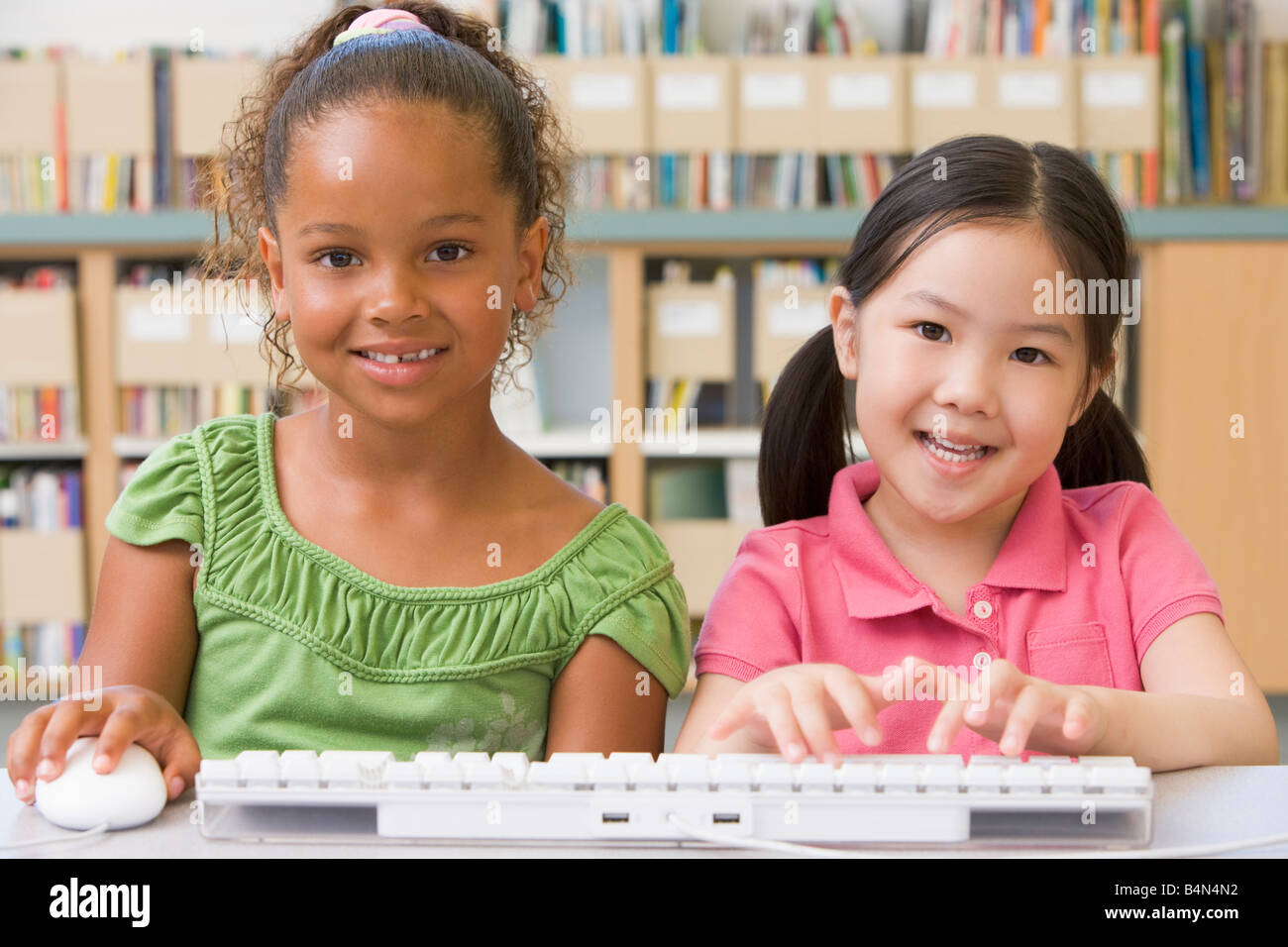 Two students in class at computer keyboard Stock Photo - Alamy