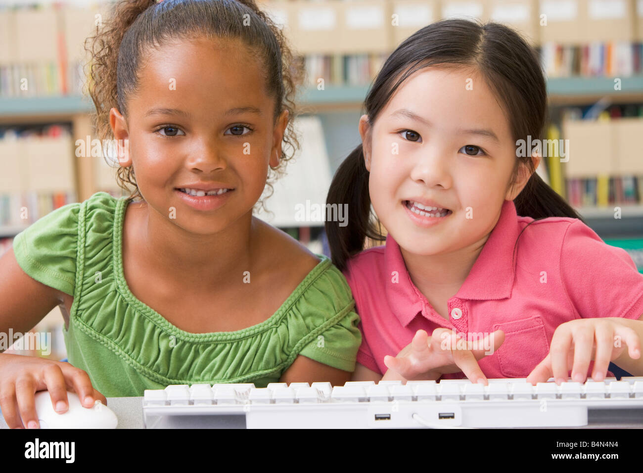 Two students in class at computer keyboard Stock Photo - Alamy