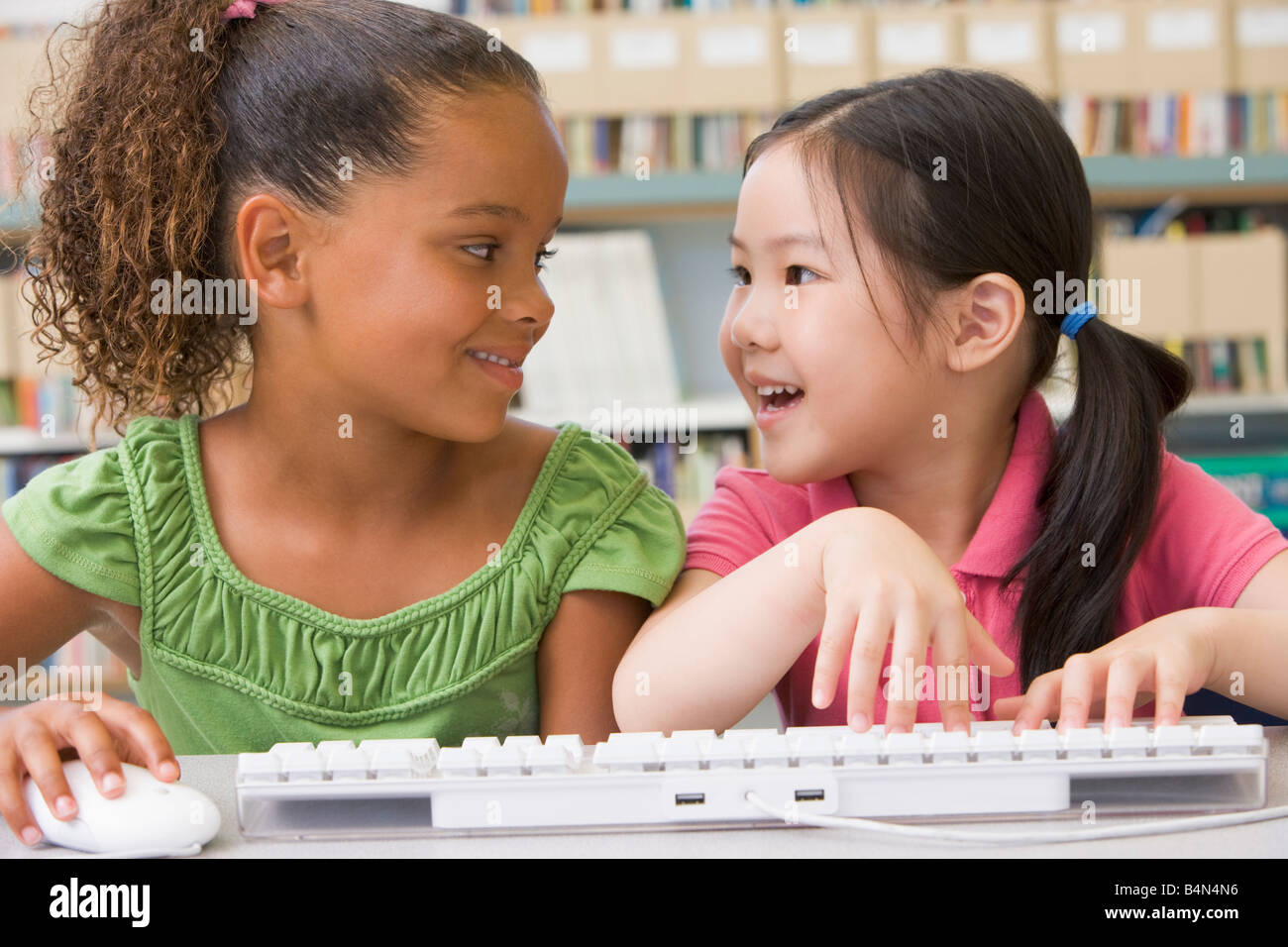 Two students in class at computer keyboard Stock Photo - Alamy