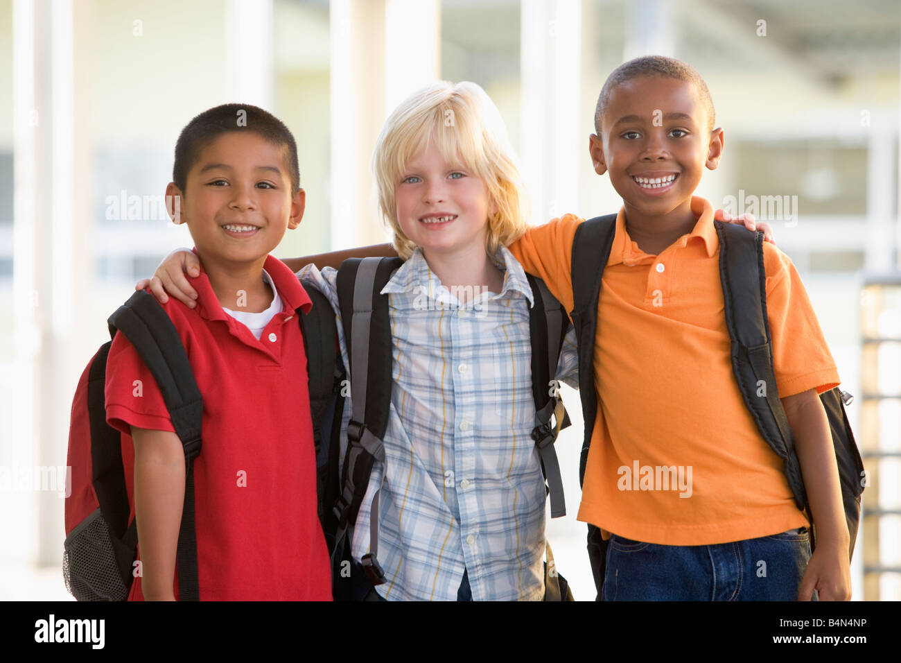 Three students outside school standing together smiling (selective ...