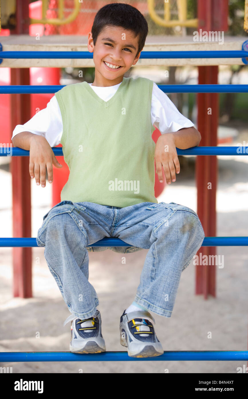 Young boy on playground structure smiling (selective focus Stock Photo ...