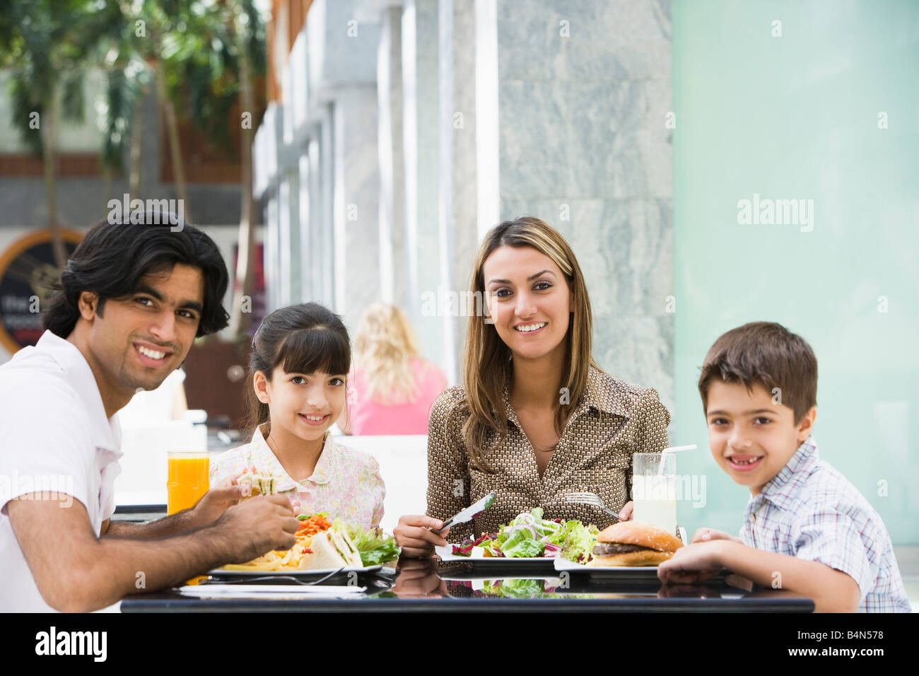 Family at restaurant eating and smiling (selective focus Stock Photo ...