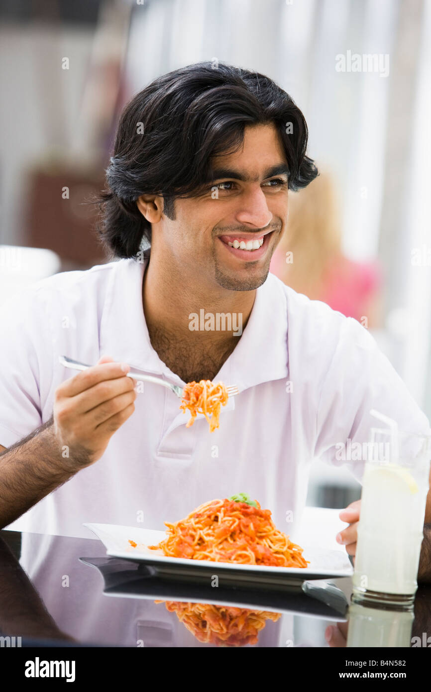 Man eating spaghetti smiling hi-res stock photography and images - Alamy