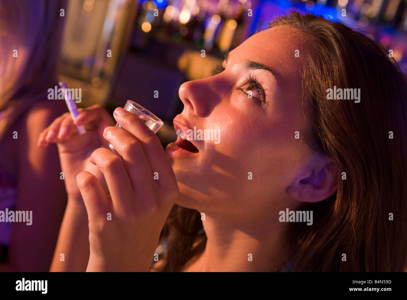 Young woman in a bar smoking Stock Photo - Alamy