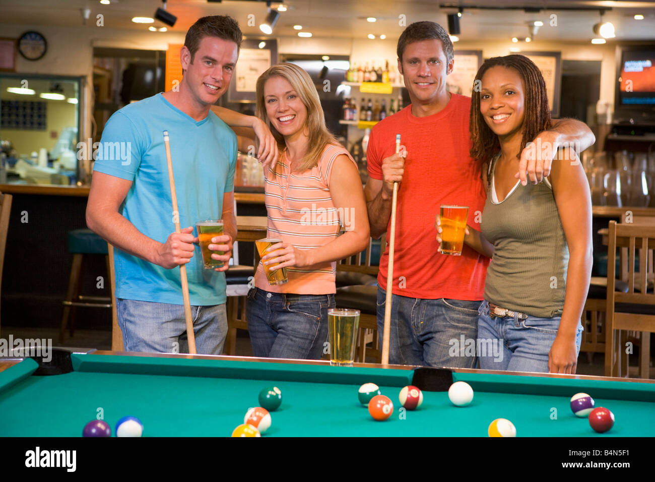 Friends at a pool hall Stock Photo - Alamy