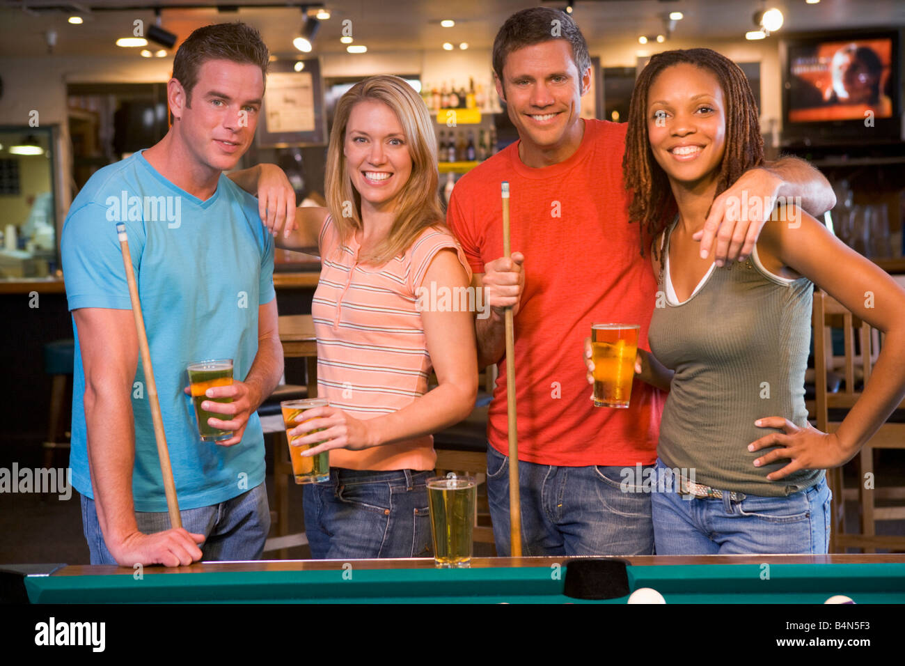 Friends at a pool hall Stock Photo - Alamy