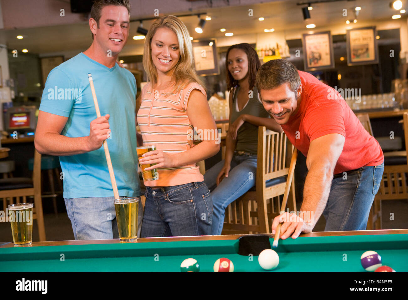 Friends playing pool Stock Photo - Alamy