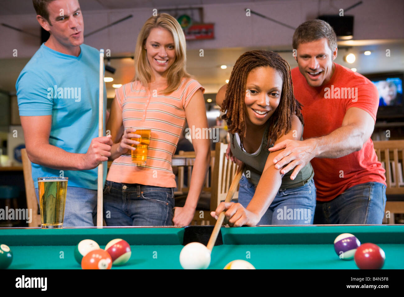 Friends playing pool Stock Photo - Alamy