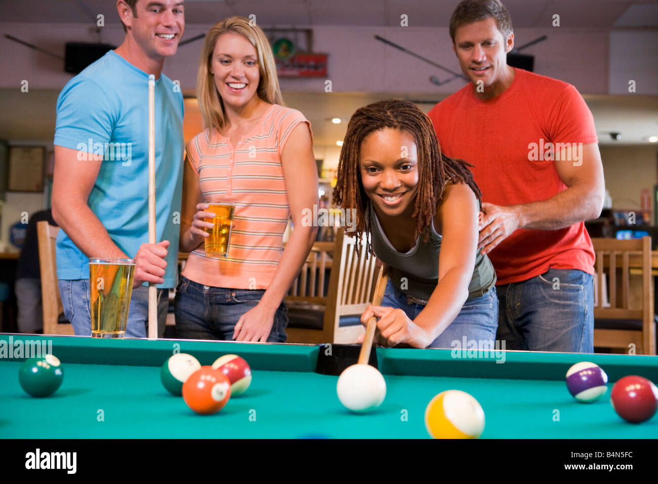 Friends playing pool Stock Photo - Alamy